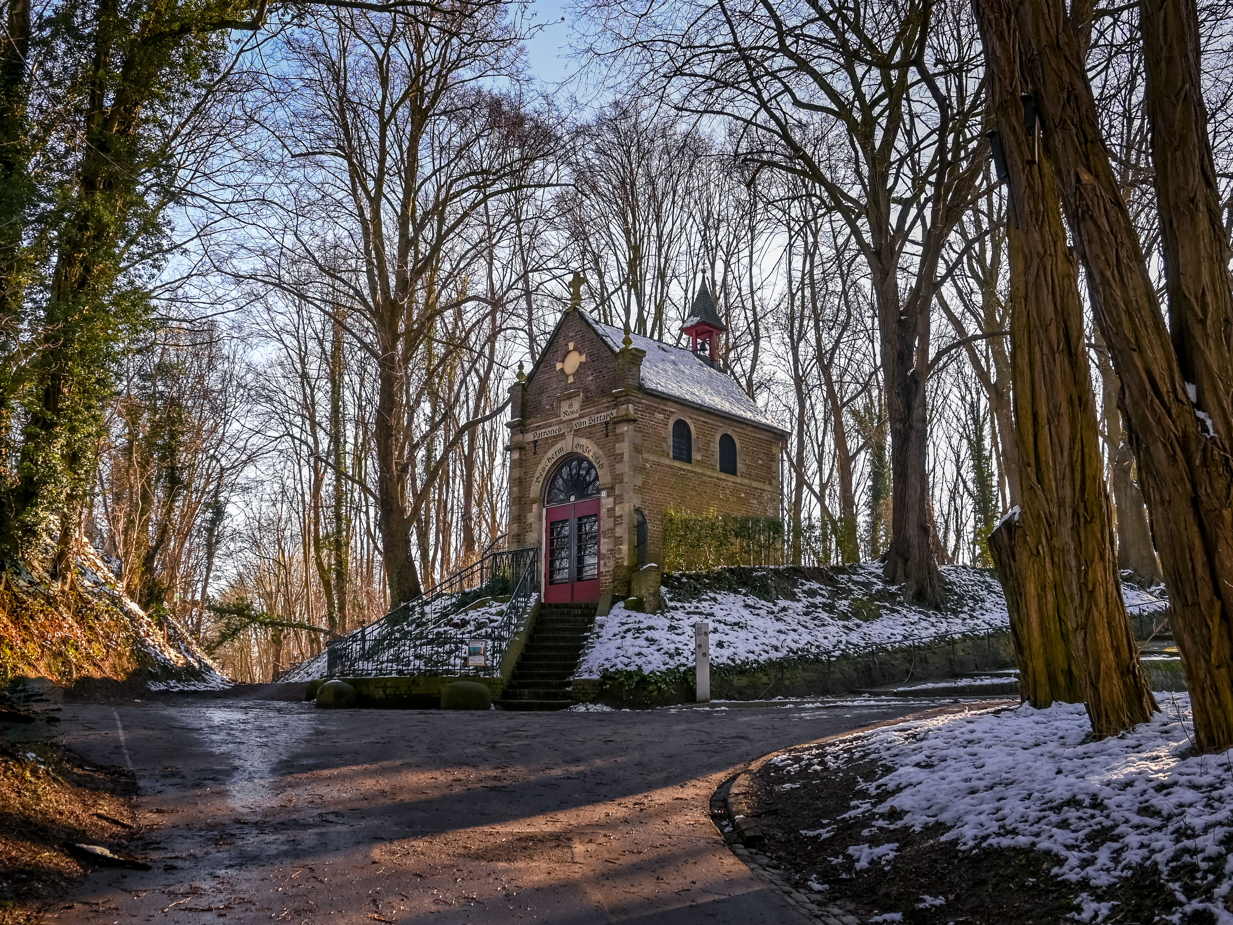 Charming Forest Chapel in Snowy Sittard Landscape · Free Stock Photo