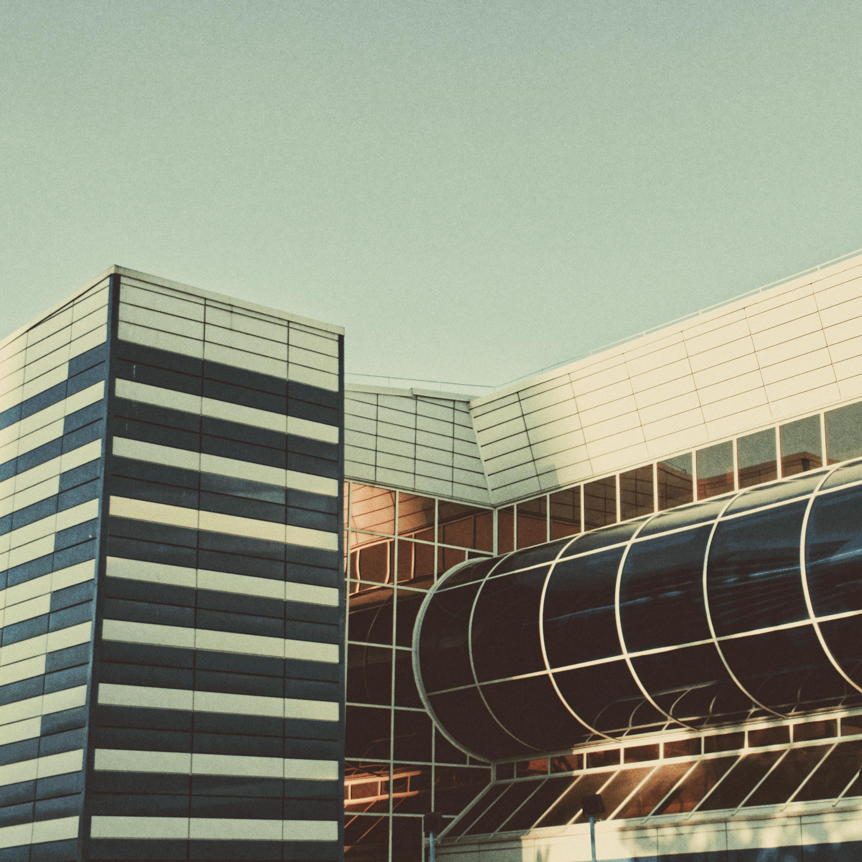 Modern Geometric Architecture with Glass Facade · Free Stock Photo