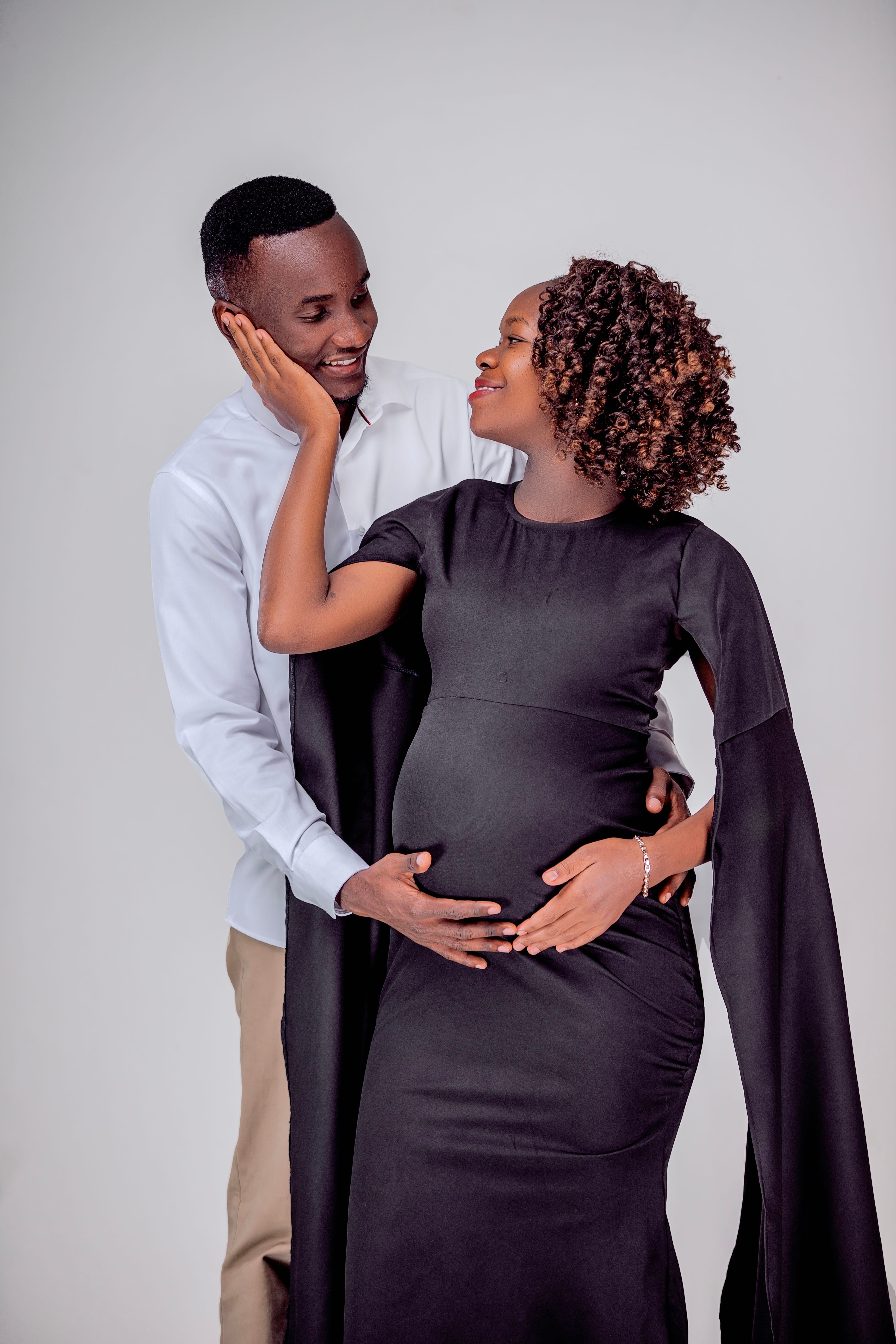 Loving Expectant Couple Embracing Joyfully · Free Stock Photo