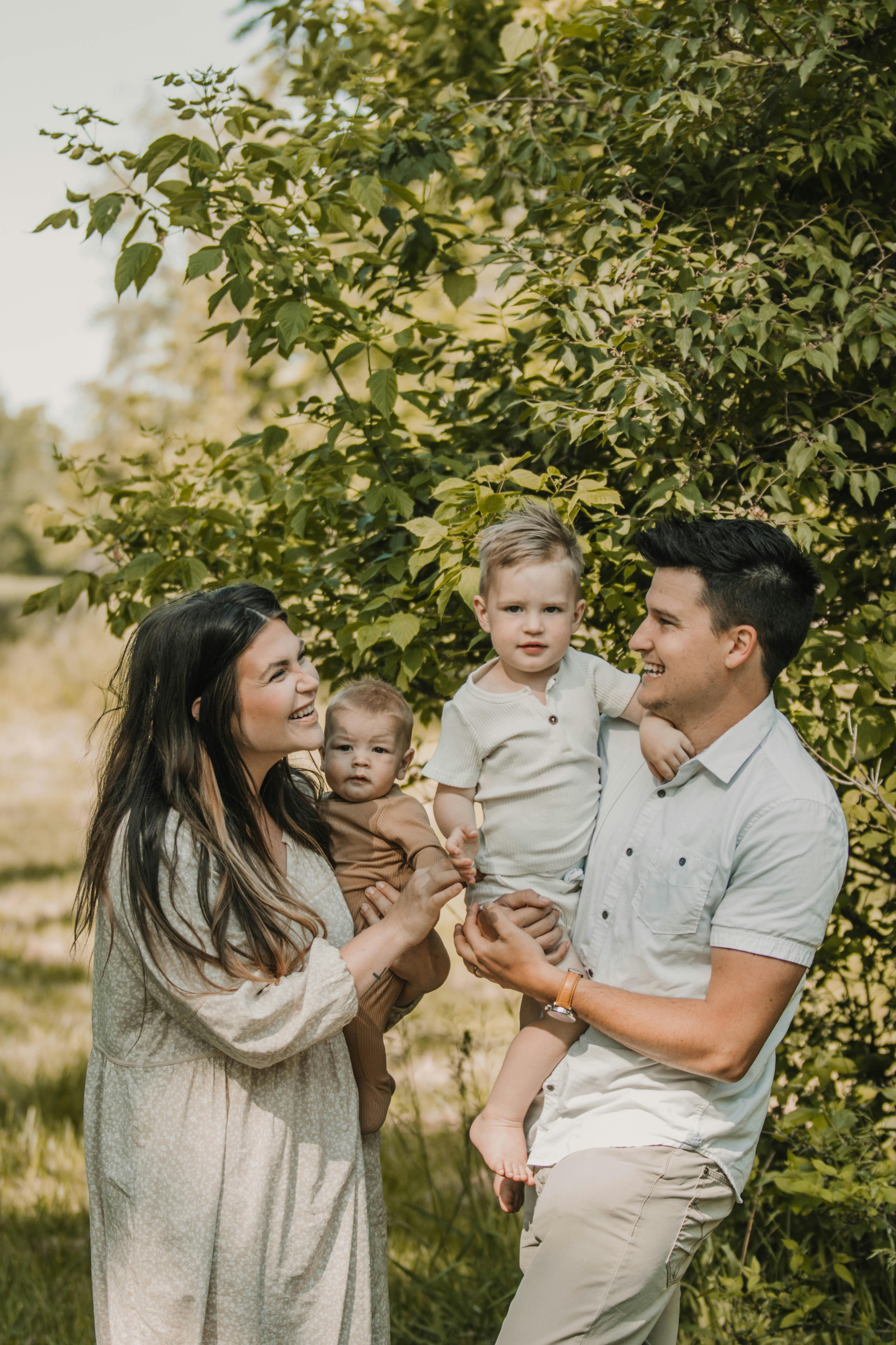 Charming Family Portrait in Summer Greenery · Free Stock Photo