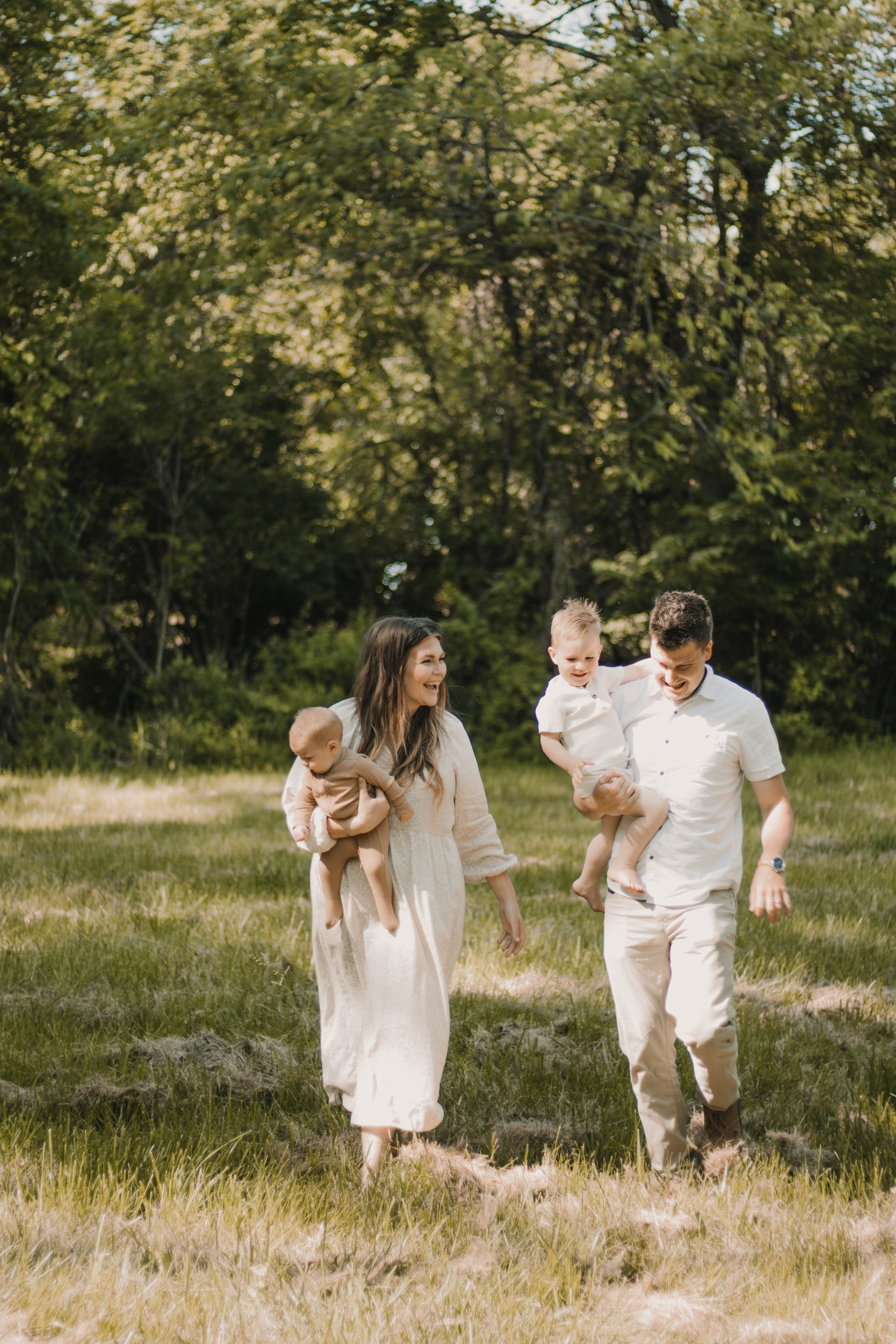 Happy Family Strolling in Sunny Woodland · Free Stock Photo