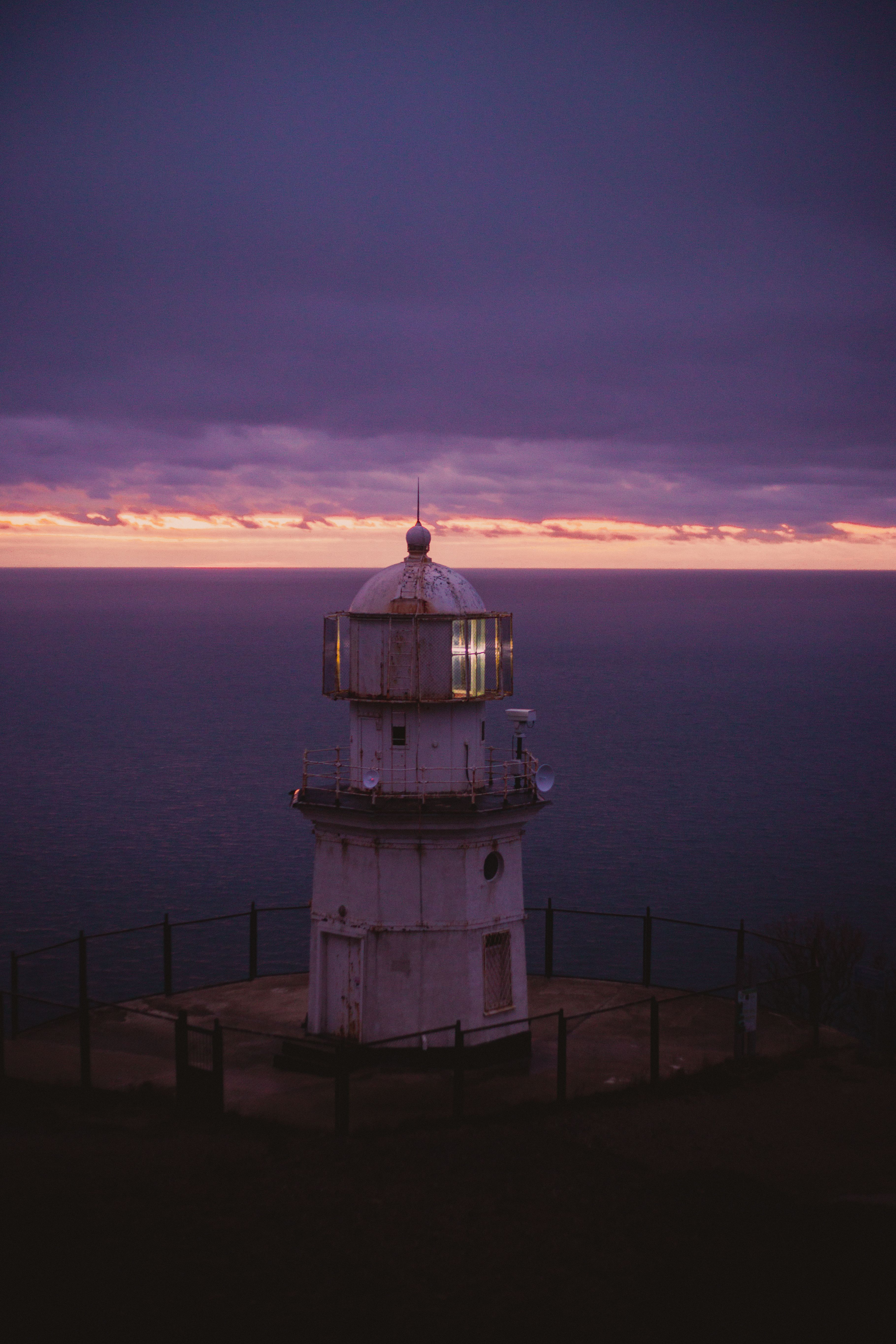 Serene Lighthouse at Twilight by the Sea · Free Stock Photo