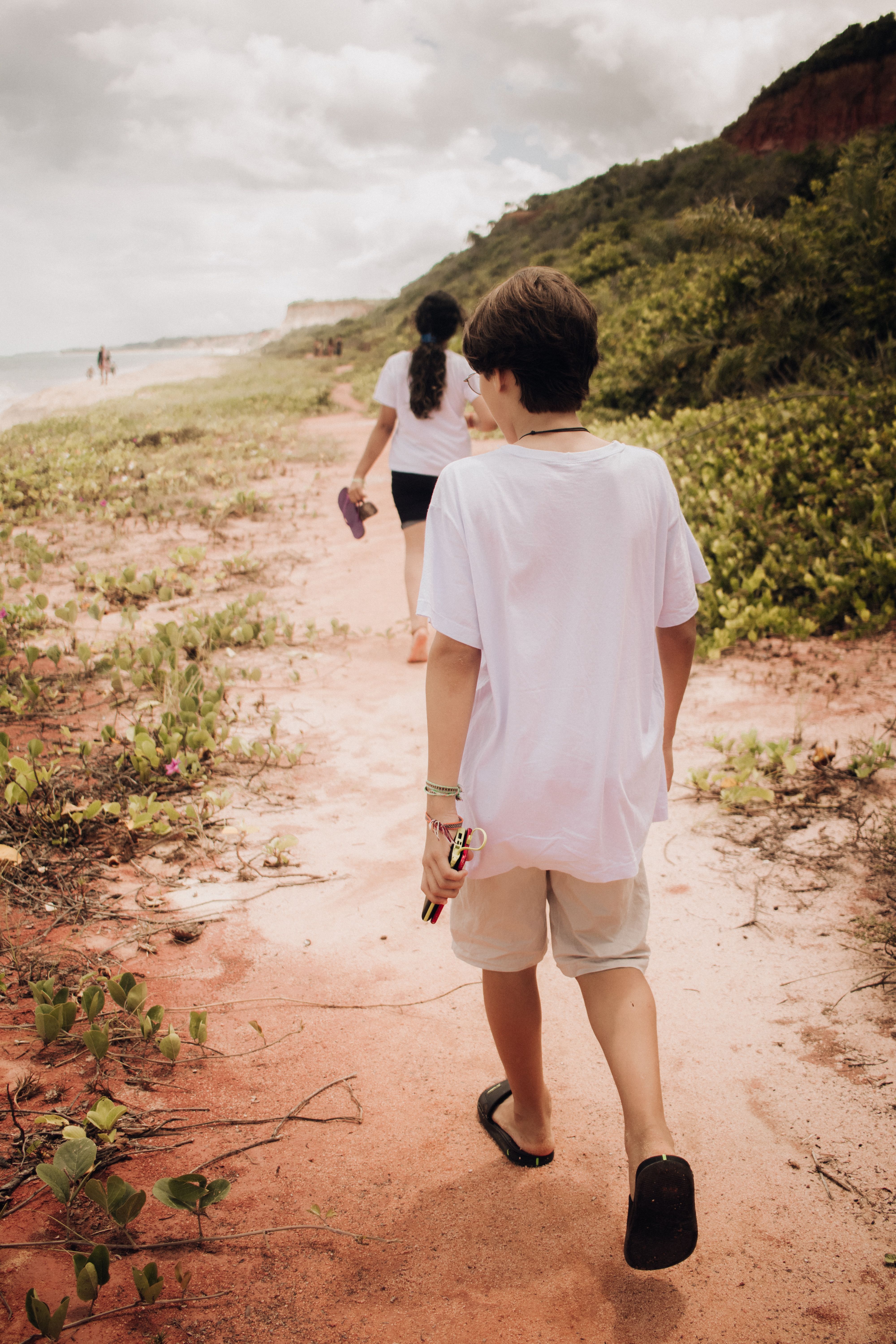 Children Walking on a Scenic Beach Path · Free Stock Photo