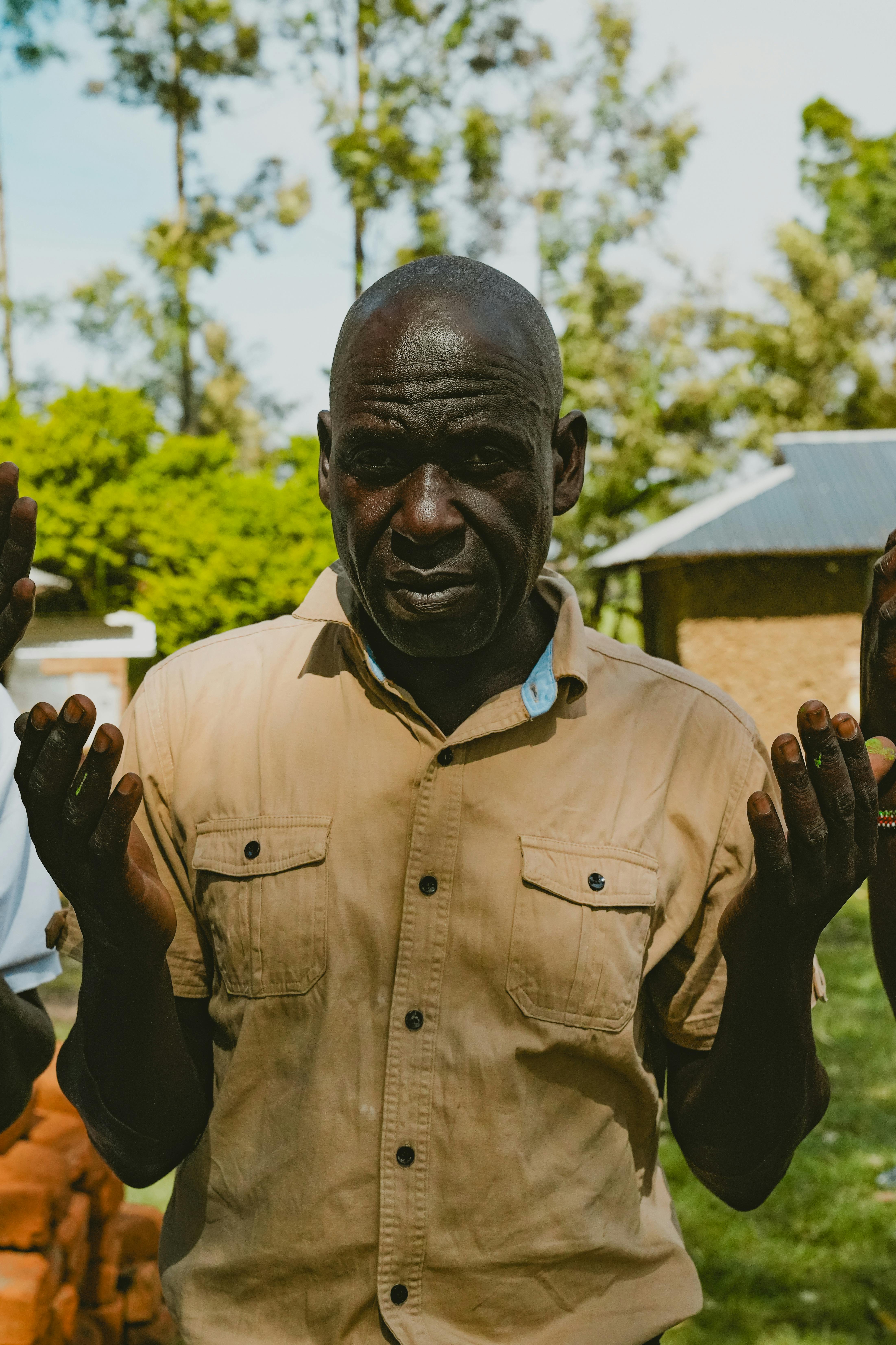Man Praying Outdoors in Sunlit Garden · Free Stock Photo