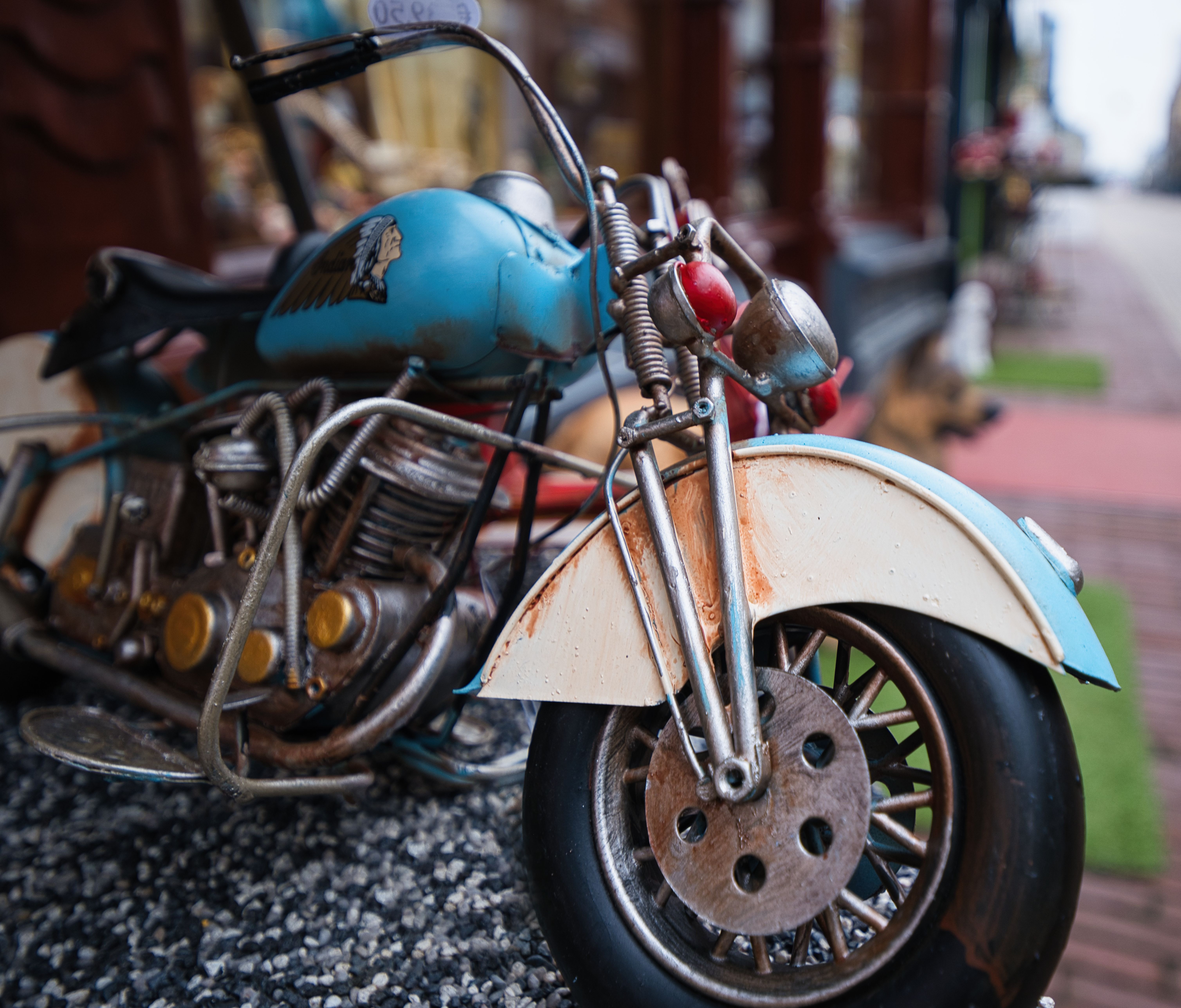 Close-up of Vintage Toy Motorcycle Model Outdoors · Free Stock Photo