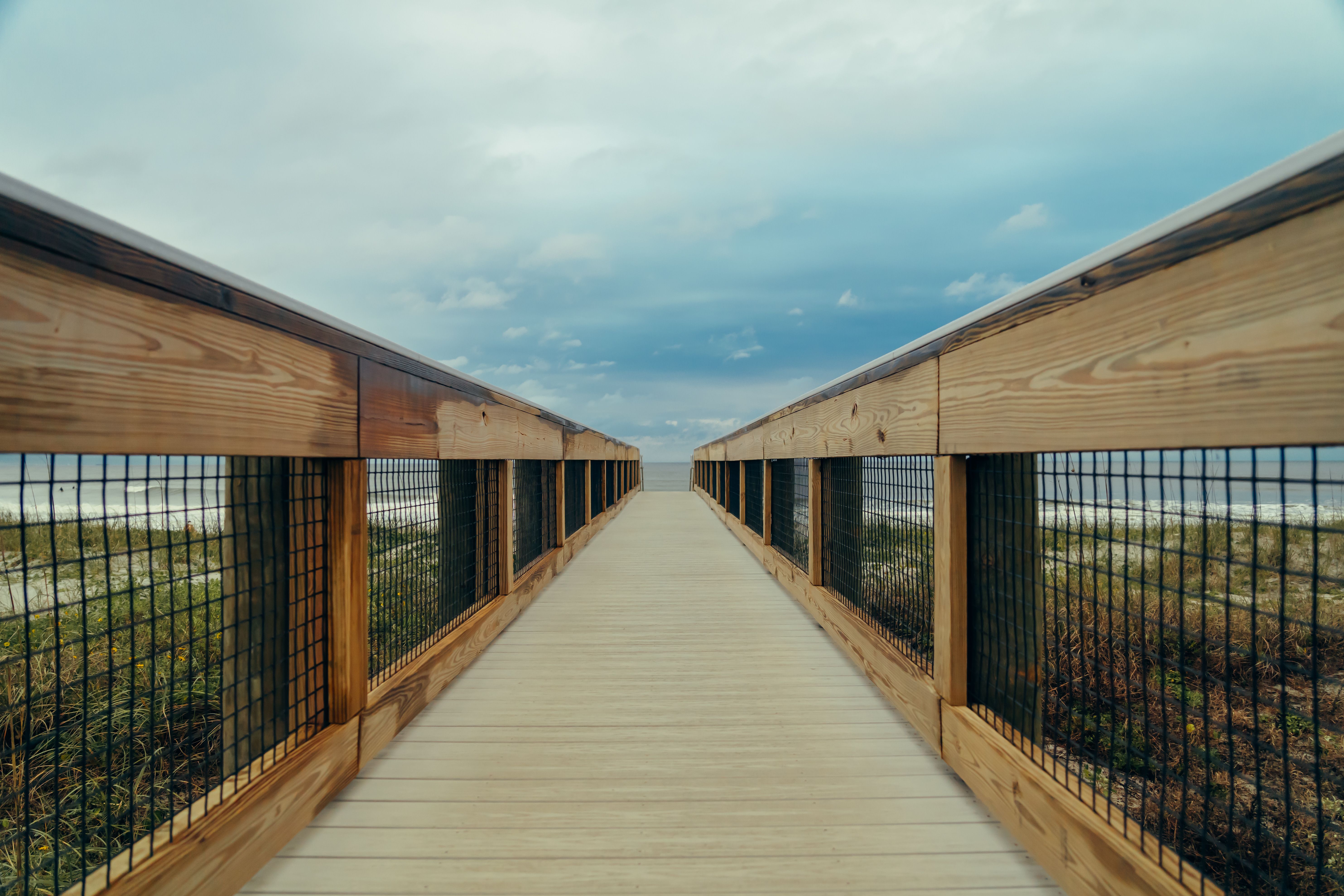 Scenic Wooden Boardwalk Leading to Ocean View · Free Stock Photo