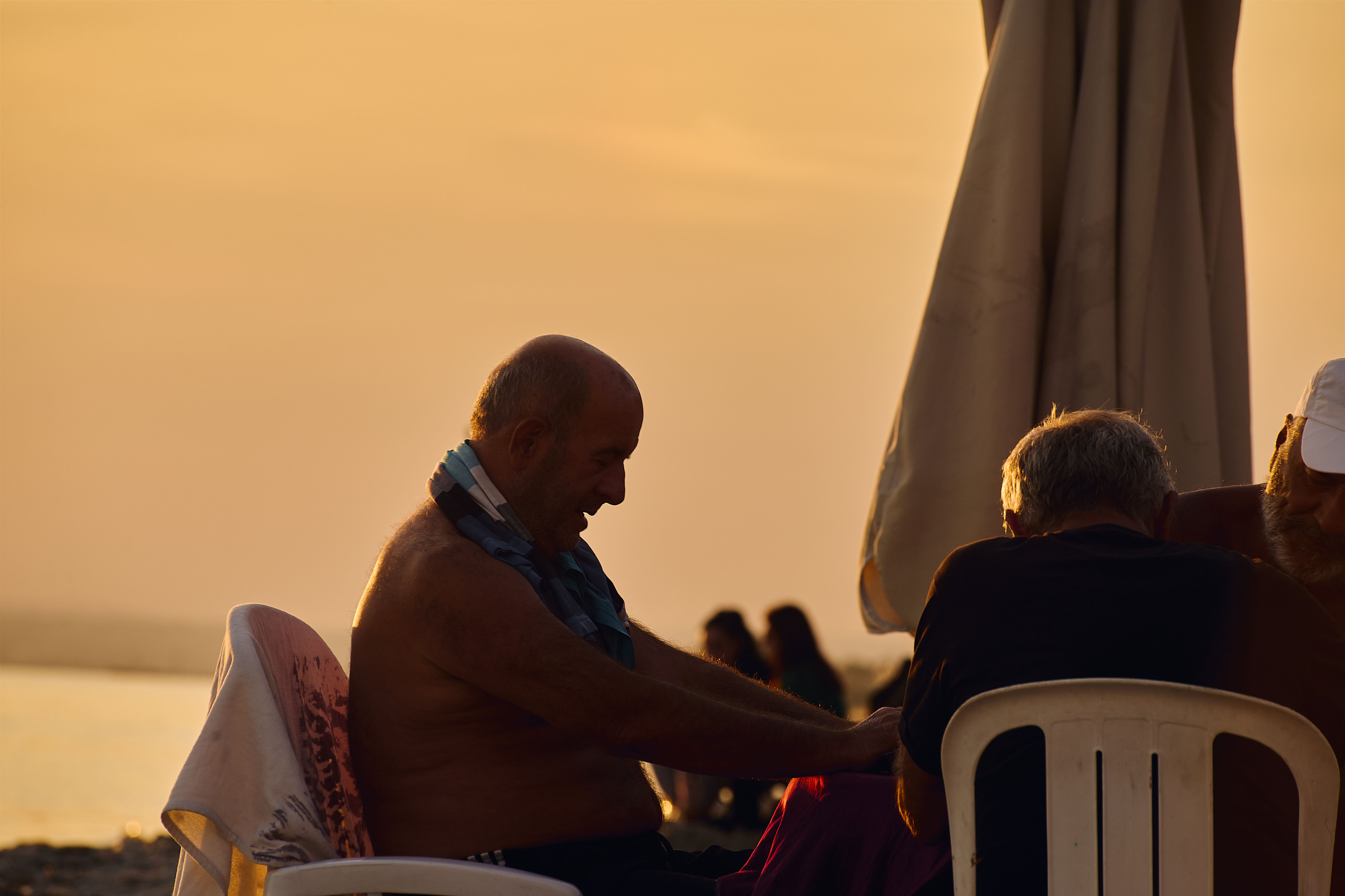 Relaxing Sunset by the Sea with Friends · Free Stock Photo