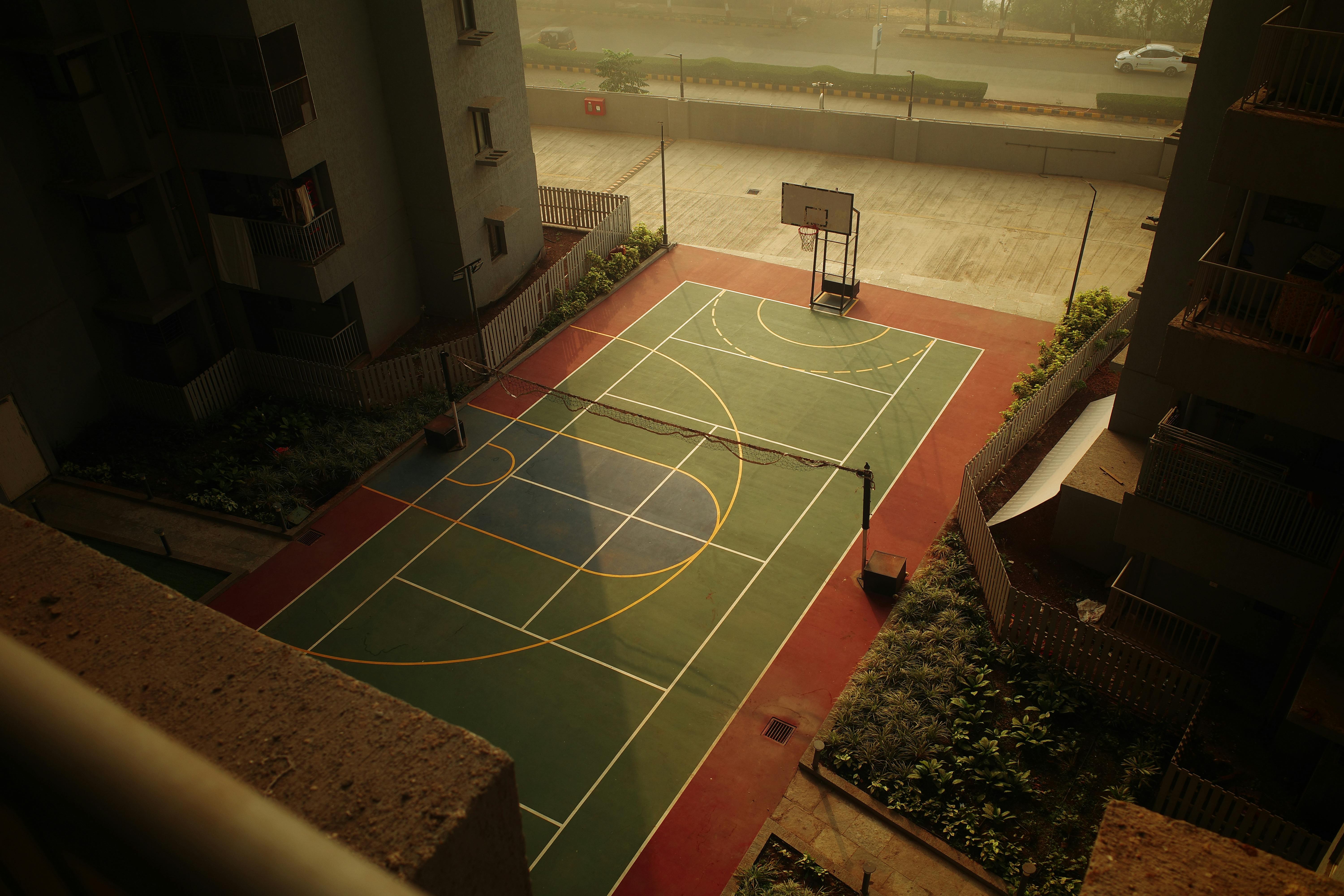 Empty urban basketball and tennis court at sunset · Free Stock Photo