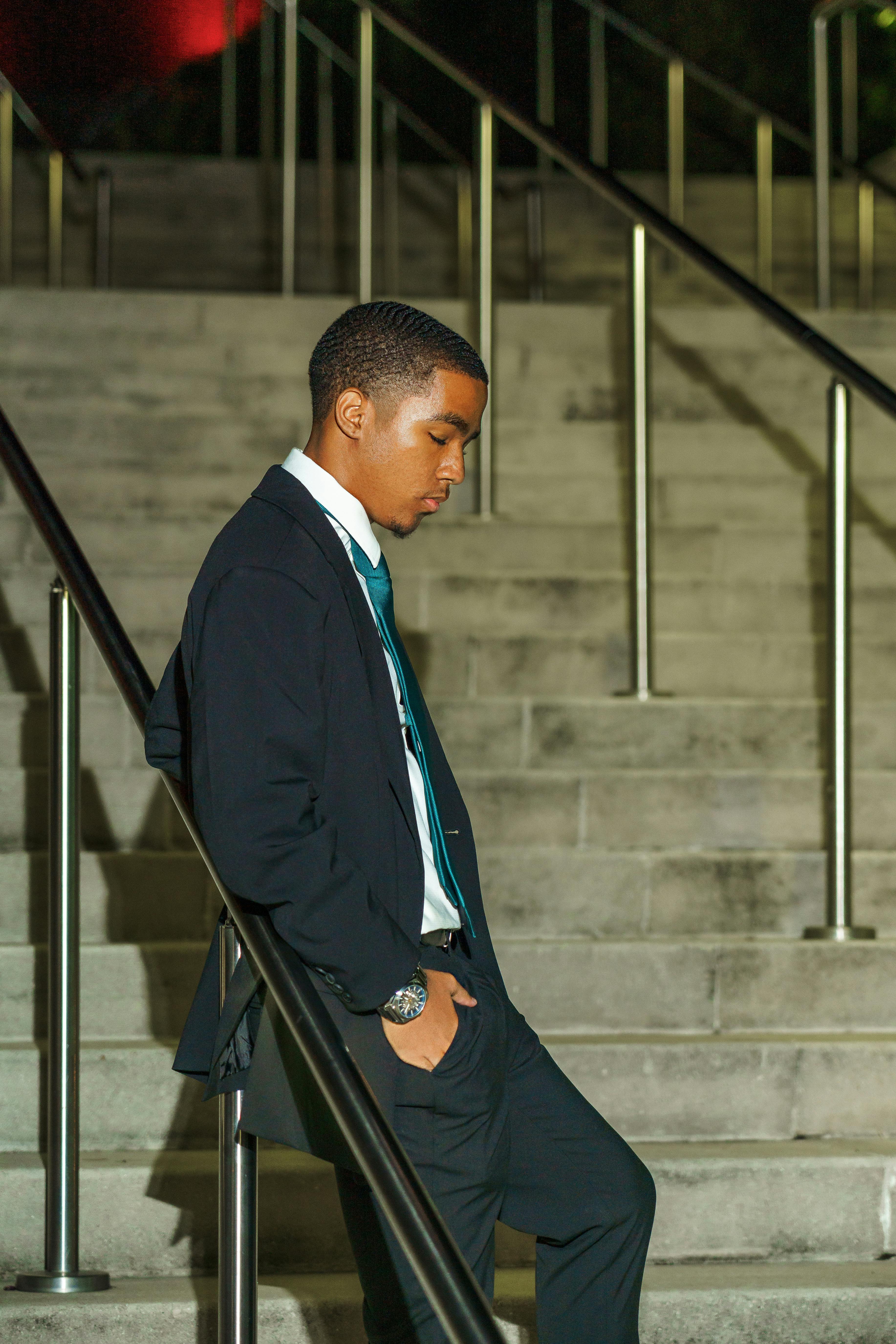 Teenager in Formal Attire on a Staircase · Free Stock Photo