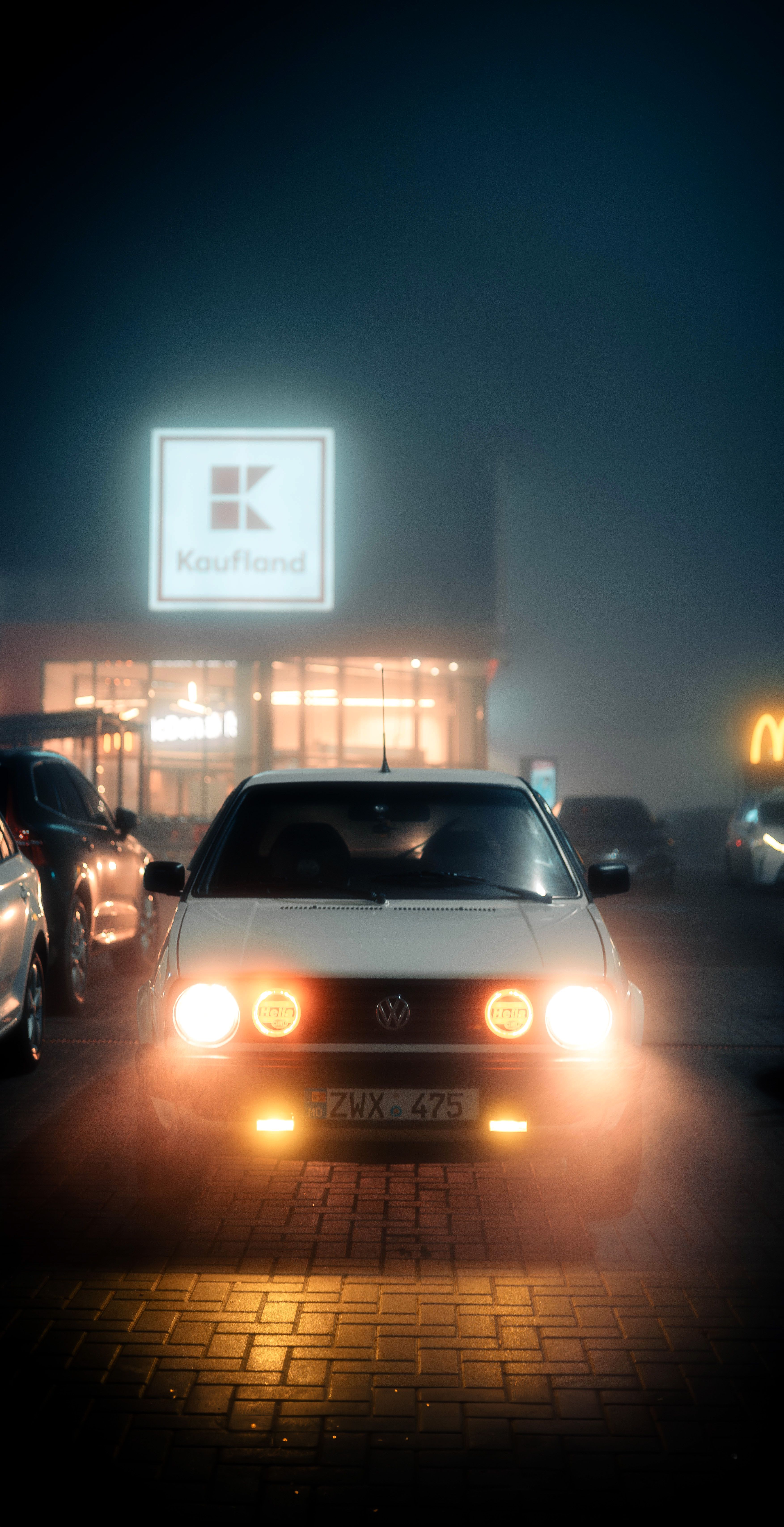 Nighttime Scene with Car in Foggy Parking Lot · Free Stock Photo