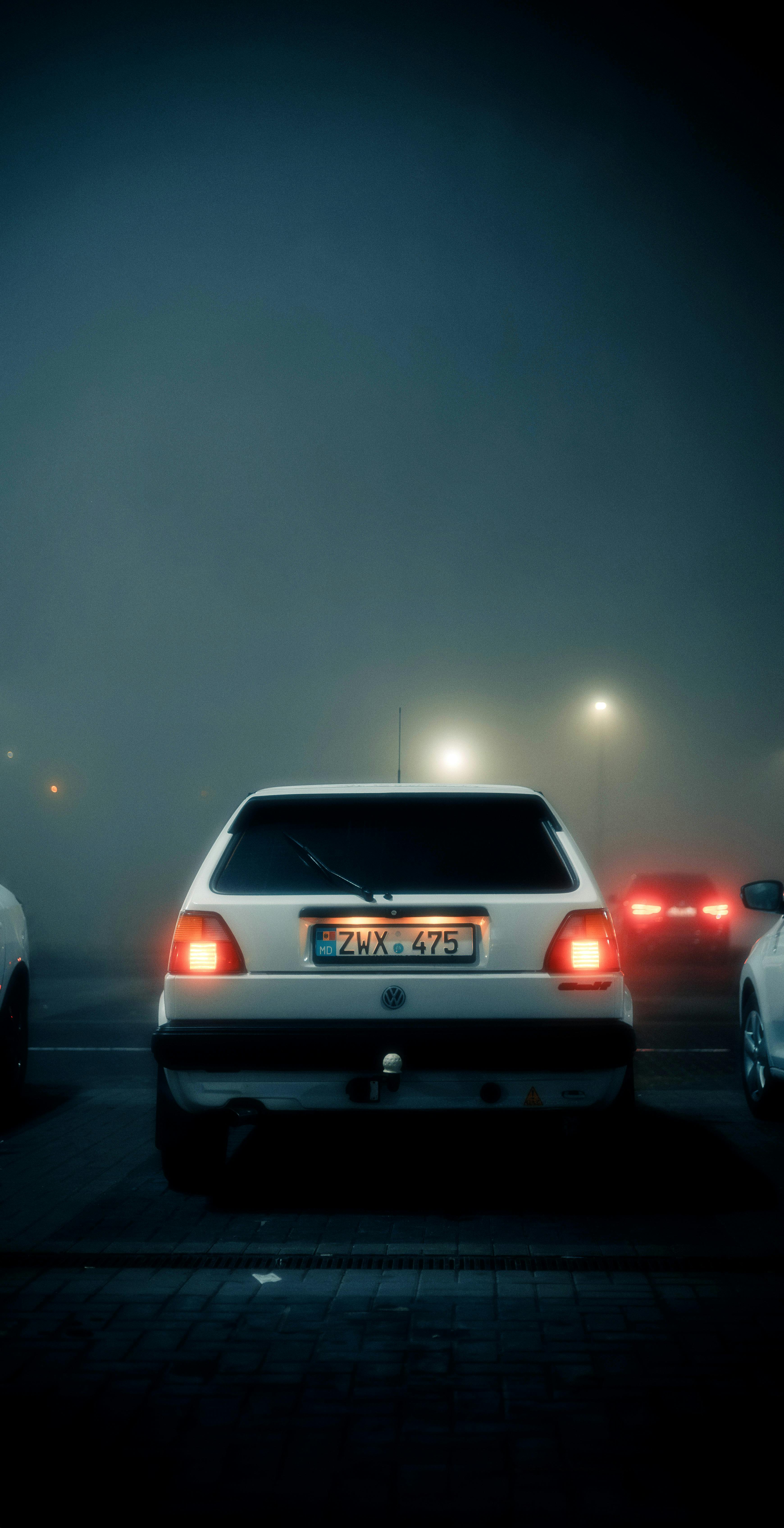 Moody Nighttime Scene of Rear Car Lights · Free Stock Photo