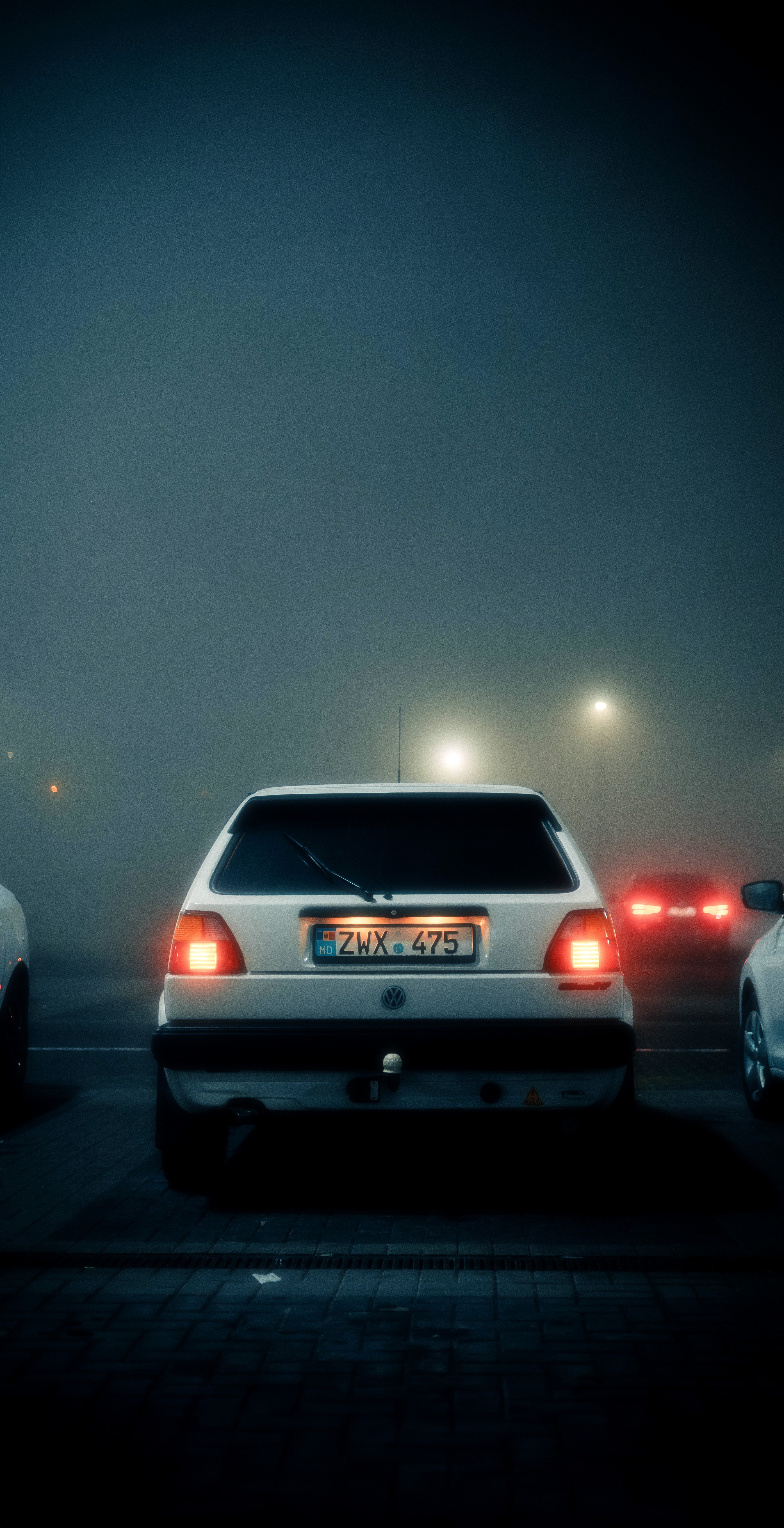 Moody Nighttime Scene of Rear Car Lights · Free Stock Photo