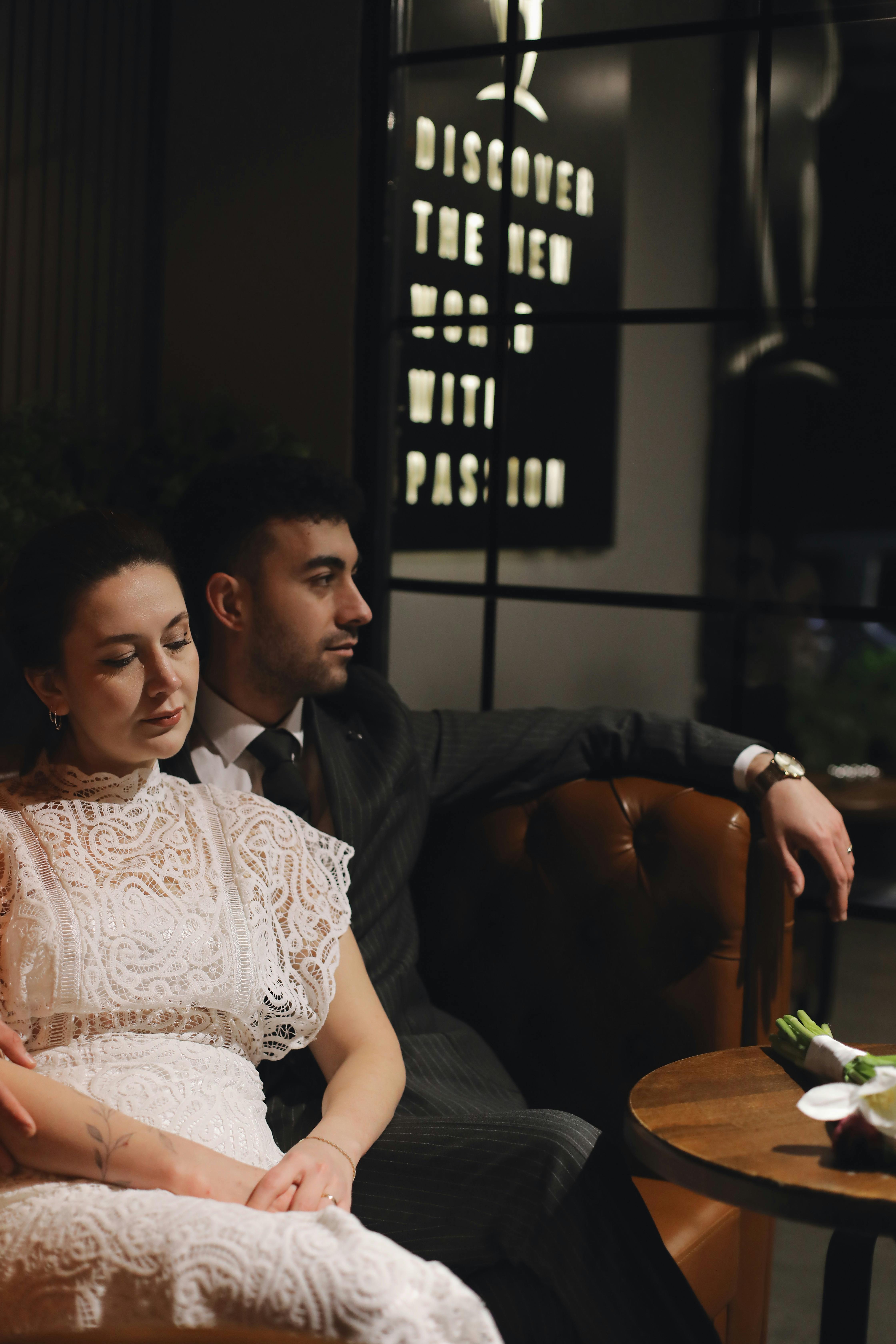 Elegant Couple Relaxed in Cozy Lounge Setting · Free Stock Photo