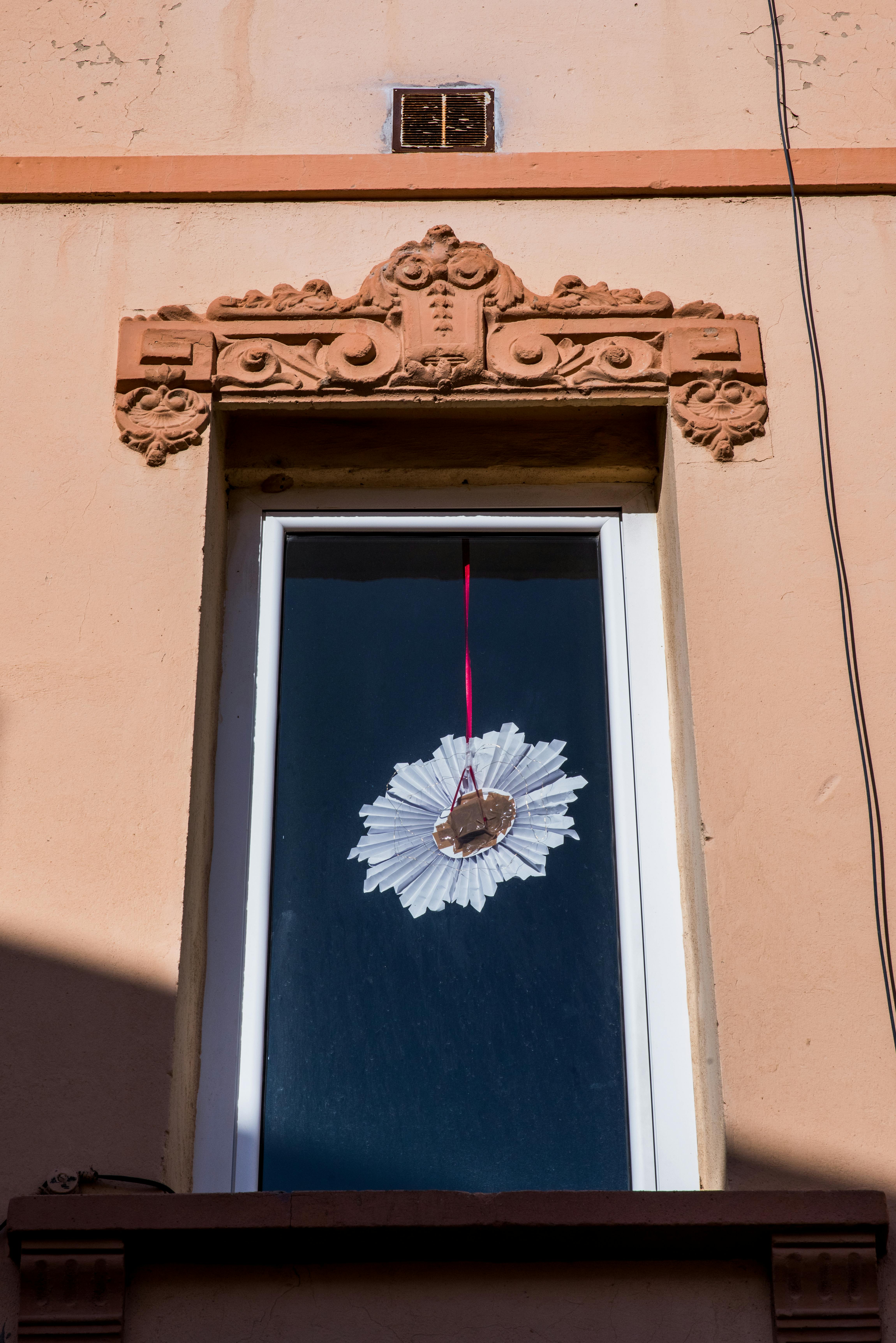 Ornate Window Frame with Hanging Paper Decoration · Free Stock Photo