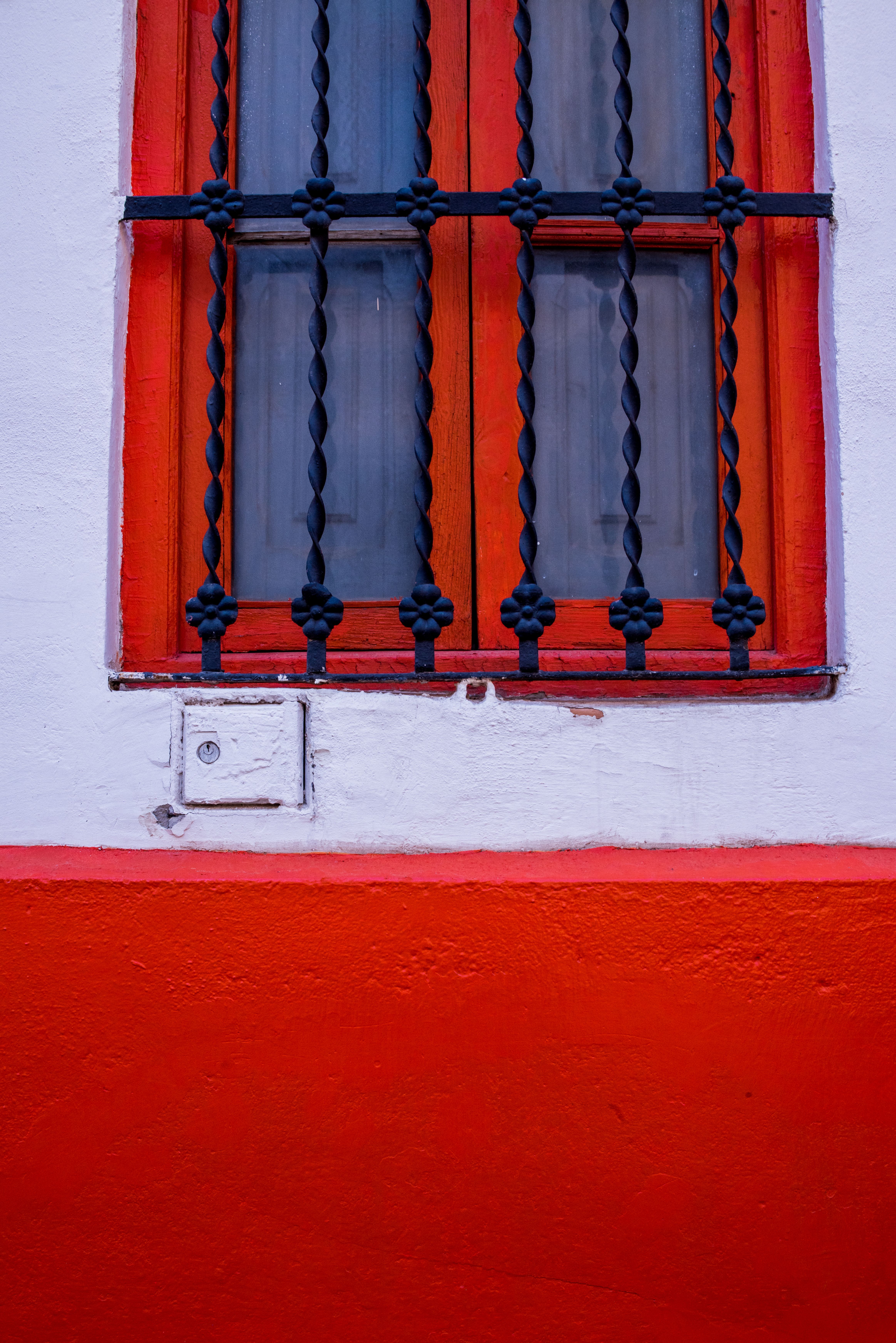 Vibrant Red and White Window Frame with Iron Bars · Free Stock Photo