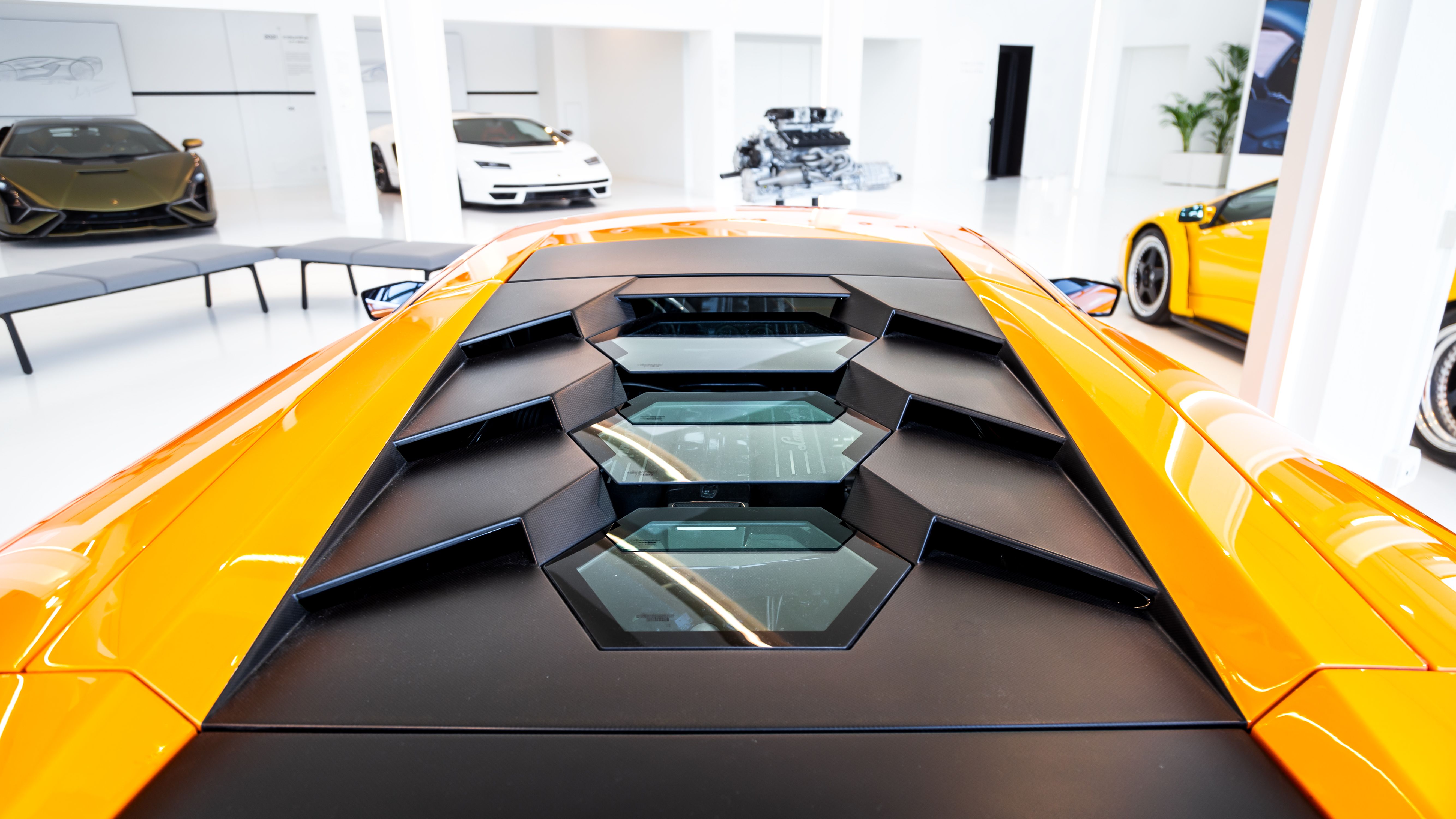 Close-Up of Orange Supercar in Luxury Showroom · Free Stock Photo