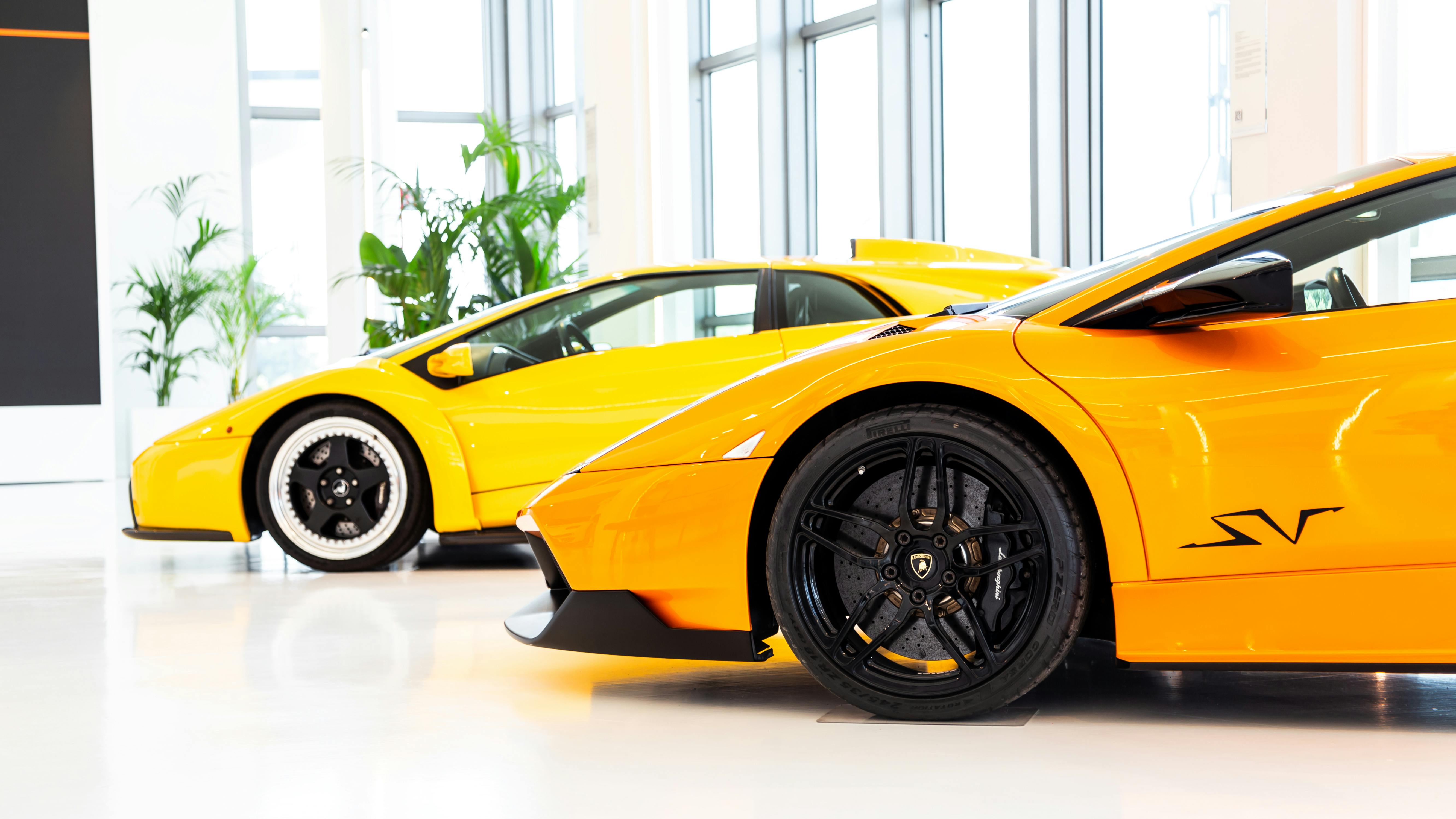Sleek Yellow Sports Cars in Showroom Display · Free Stock Photo