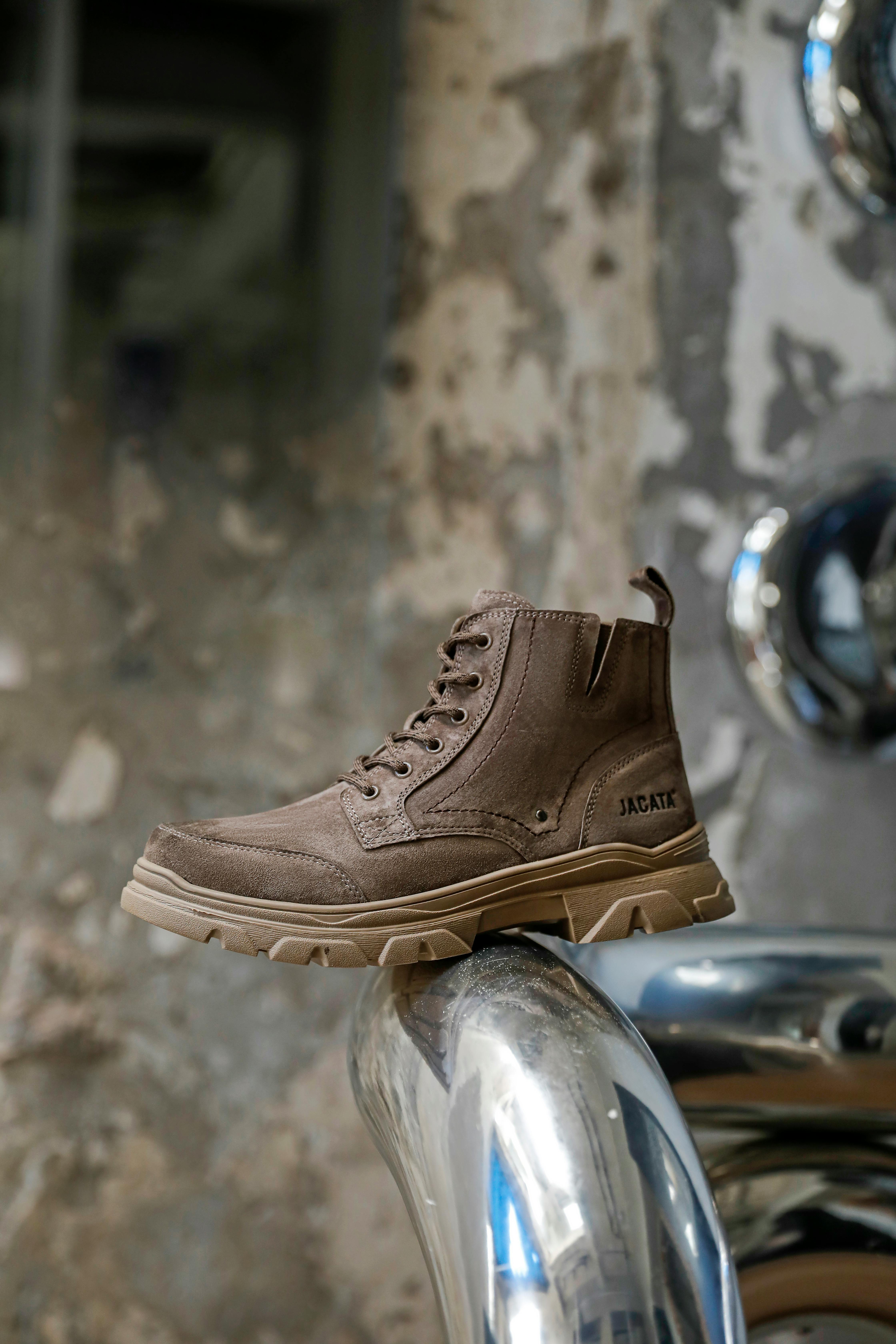 Stylish Brown Leather Boot on Industrial Background · Free Stock Photo