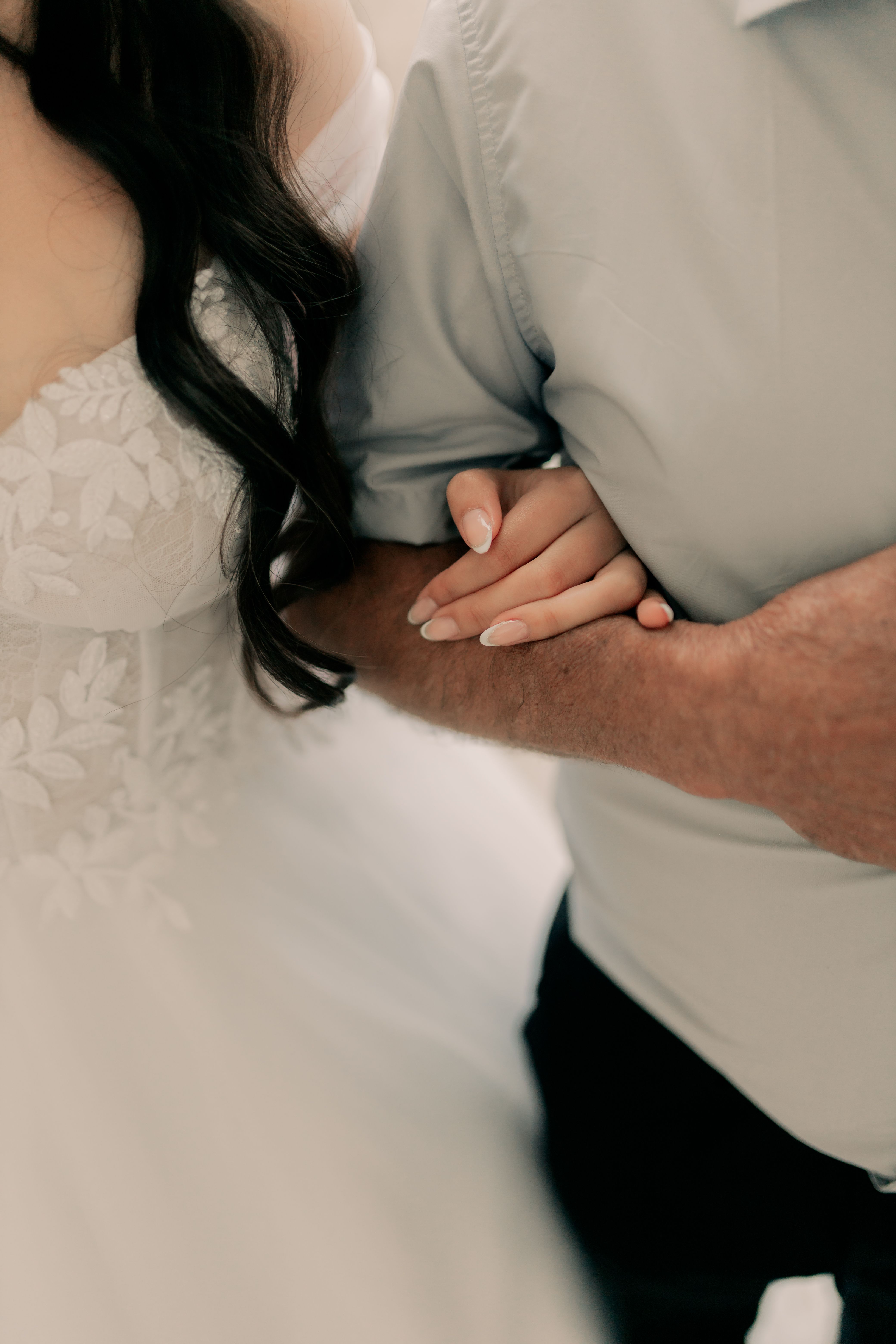 Bride Holding Arm of Groom in Elegant Wedding Dress · Free Stock Photo