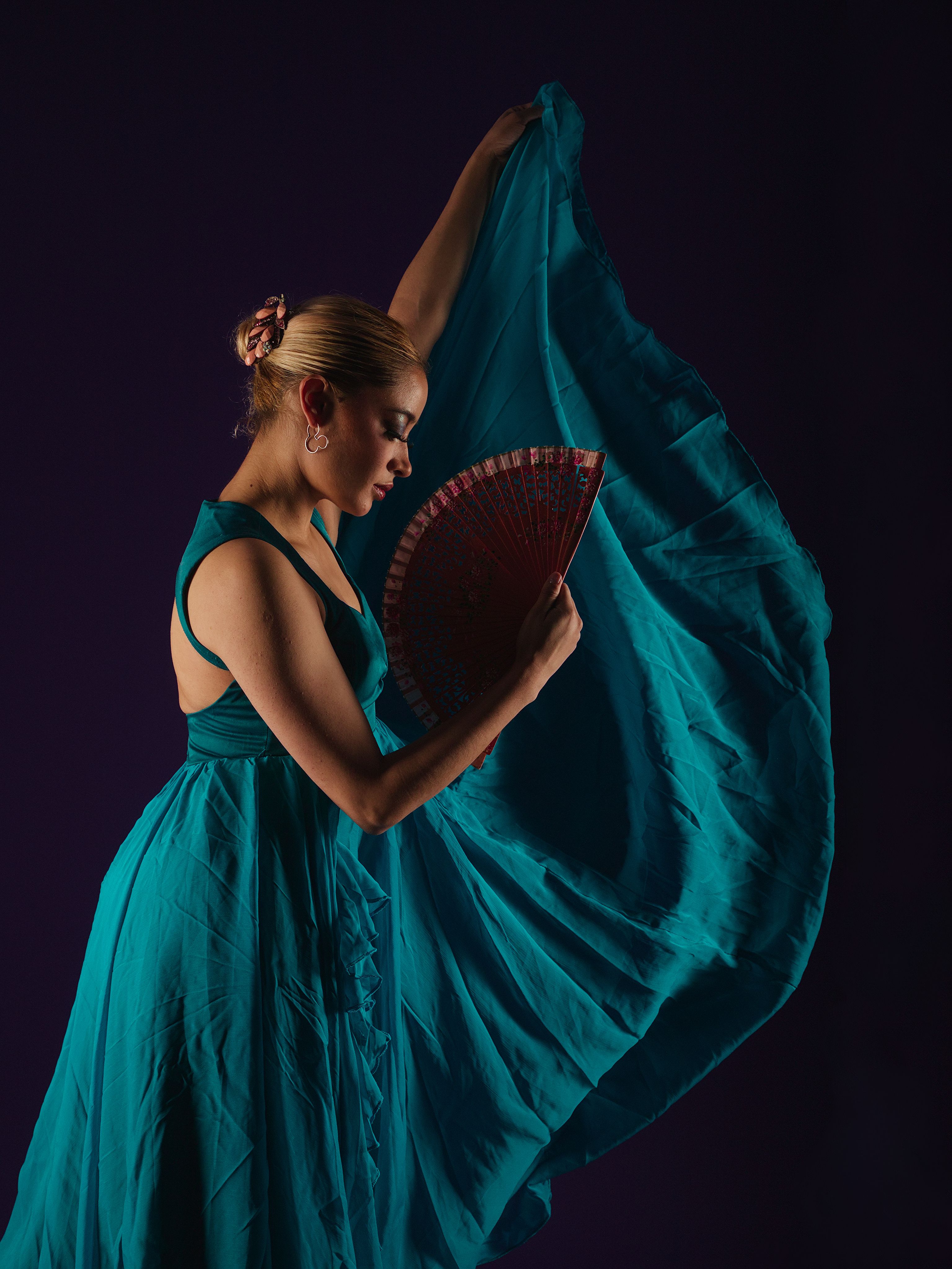 Elegant Dancer Posing with a Flowing Blue Dress · Free Stock Photo