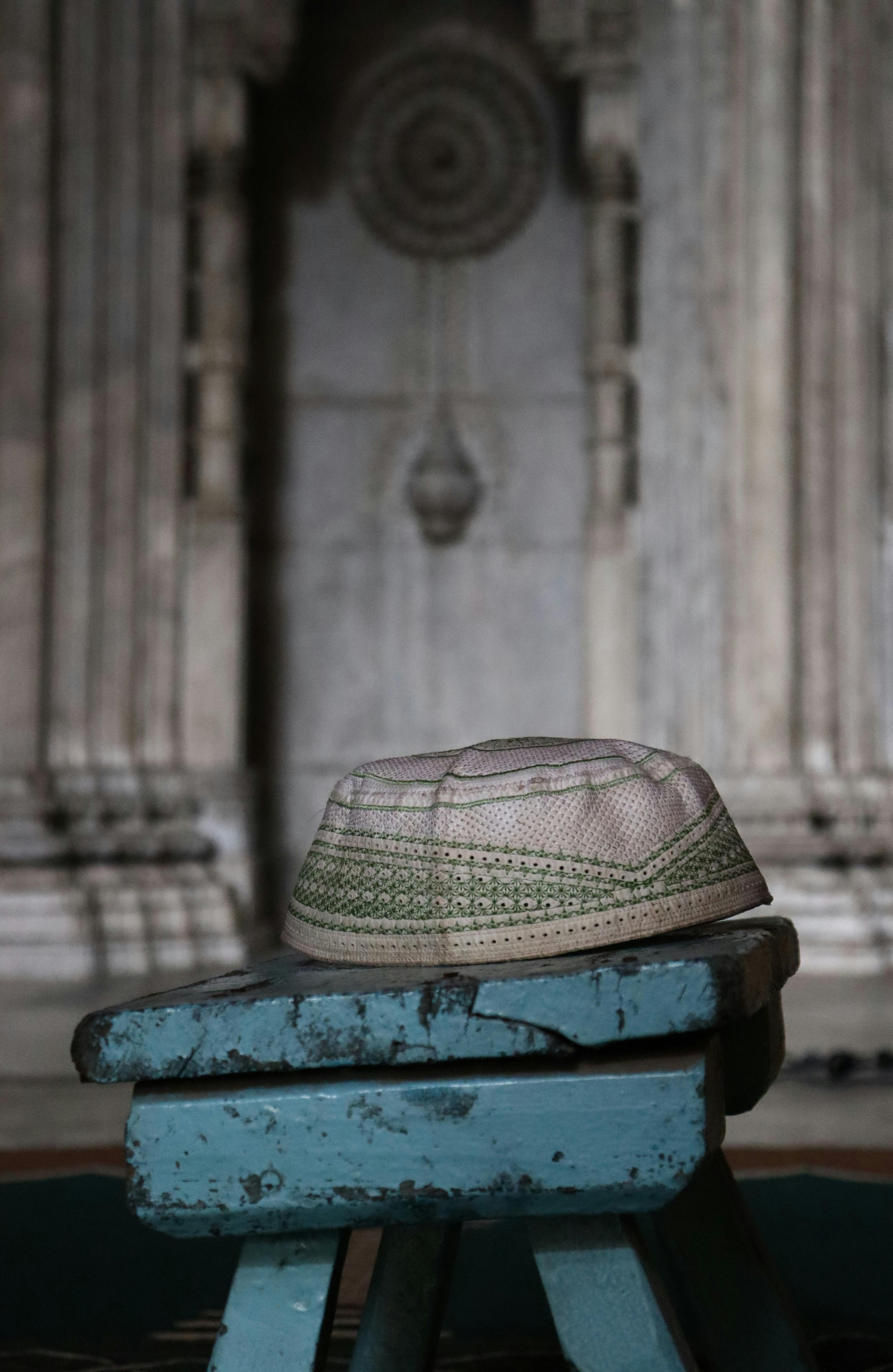 Classic Religious Hat on Rustic Wooden Stool · Free Stock Photo