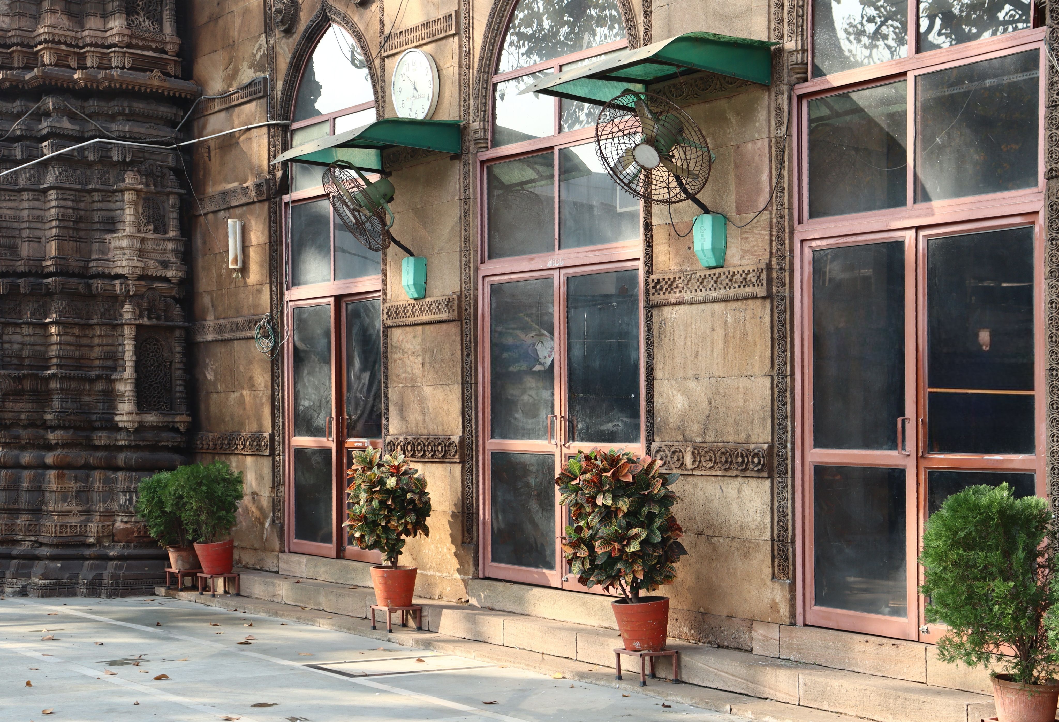 Exterior of Historic Stone Building with Potted Plants · Free Stock Photo