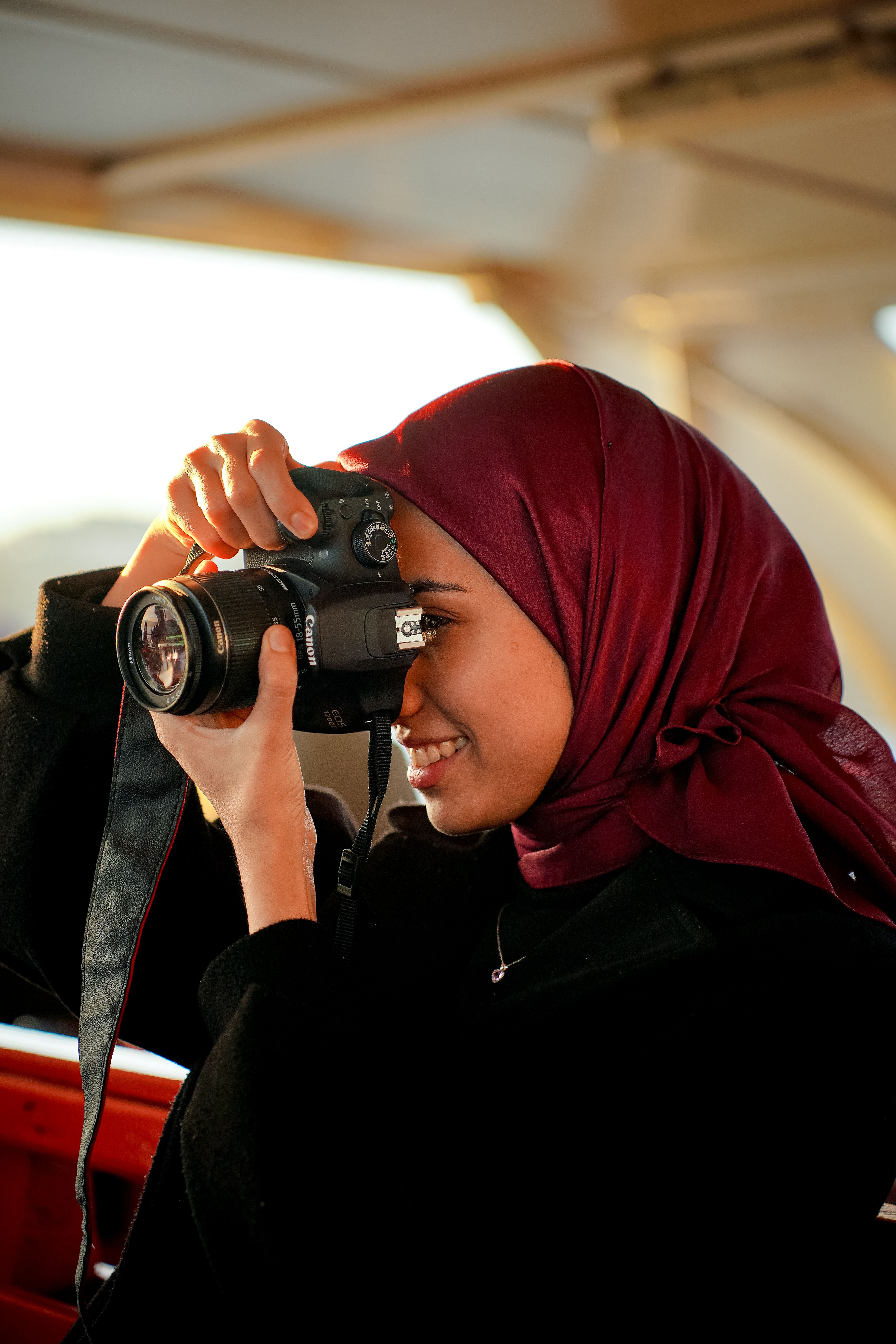 Woman Photographer Taking a Picture Indoors · Free Stock Photo