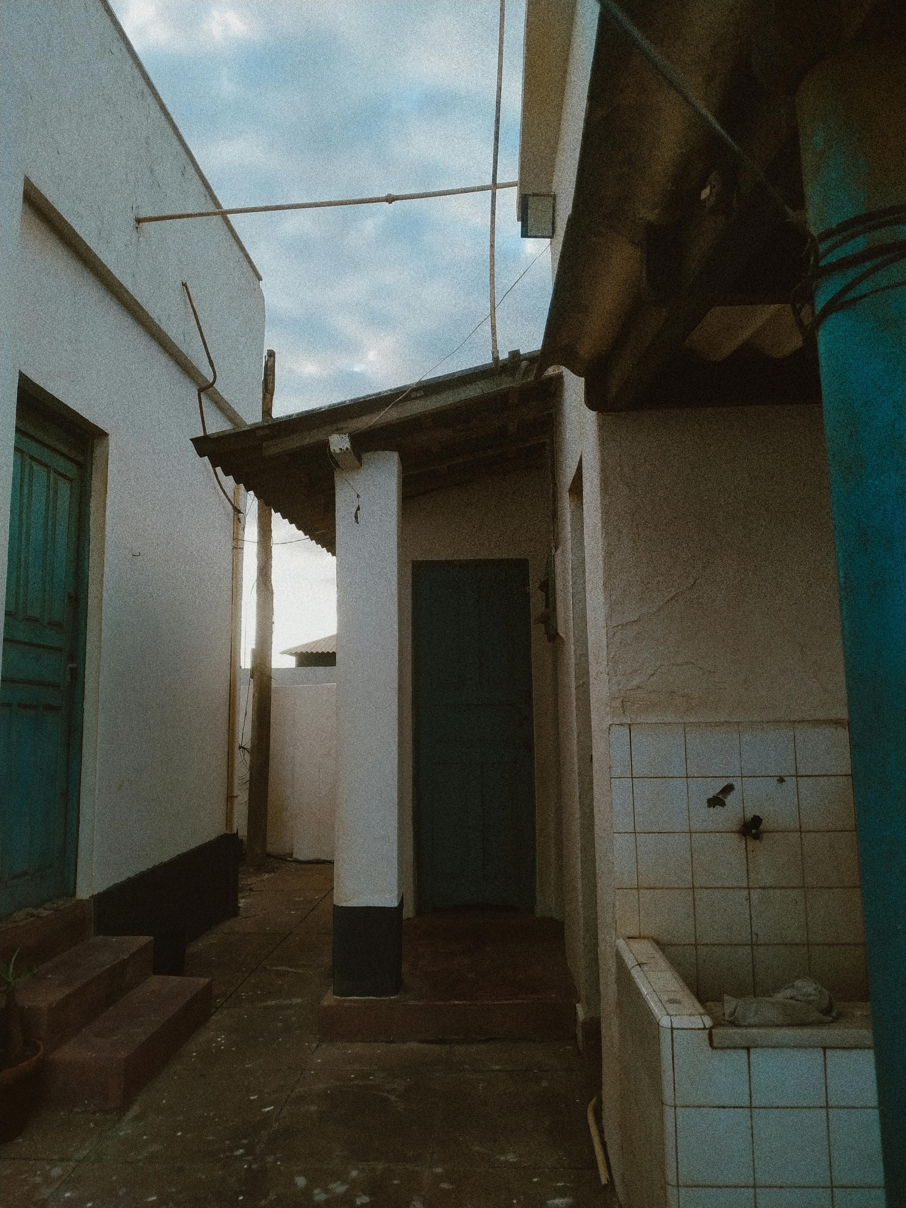 Rustic Outdoor Alley with Painted Doors · Free Stock Photo