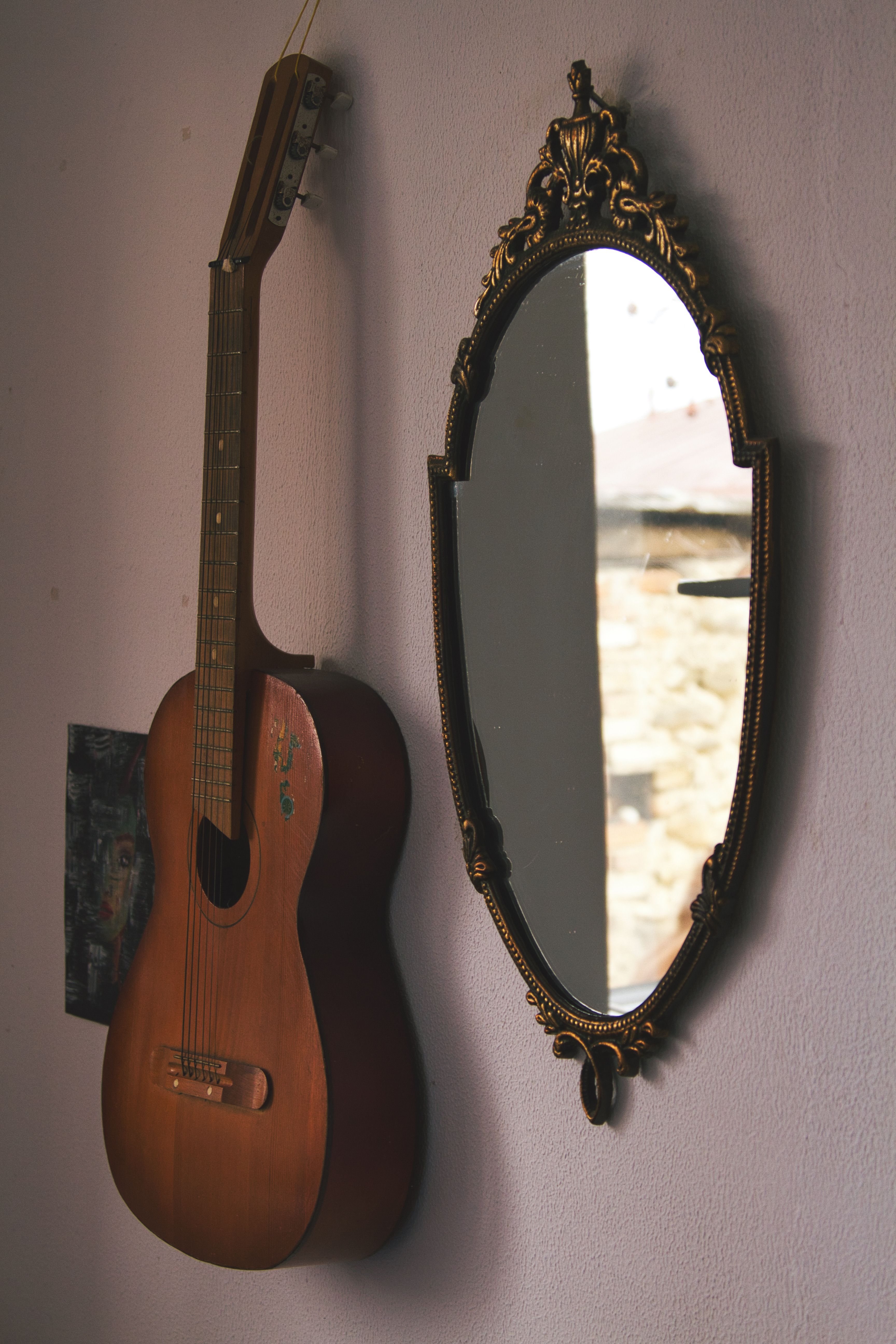 Vintage Guitar and Ornate Mirror on Wall · Free Stock Photo