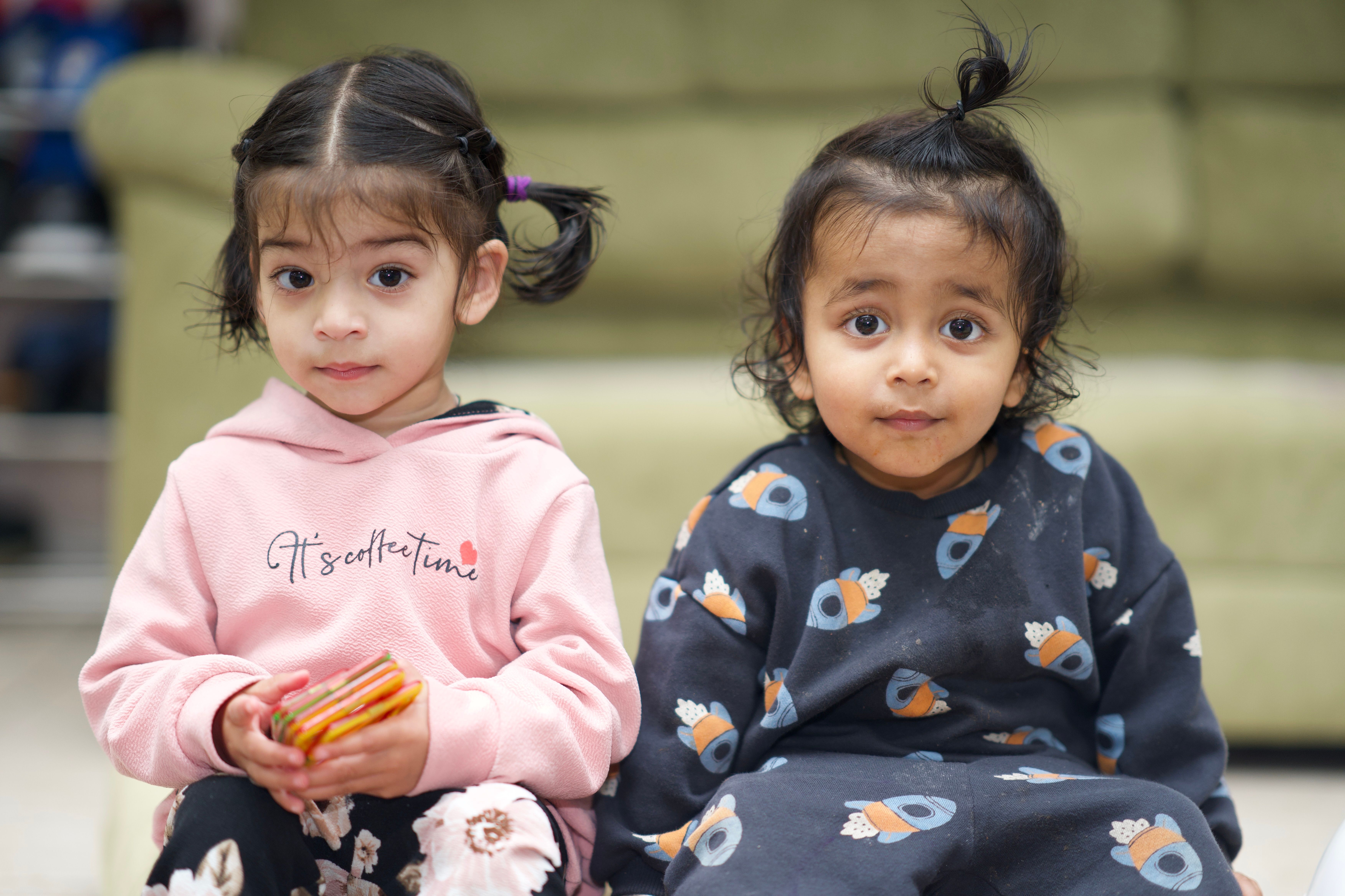 Cute toddlers sitting indoors with toys · Free Stock Photo