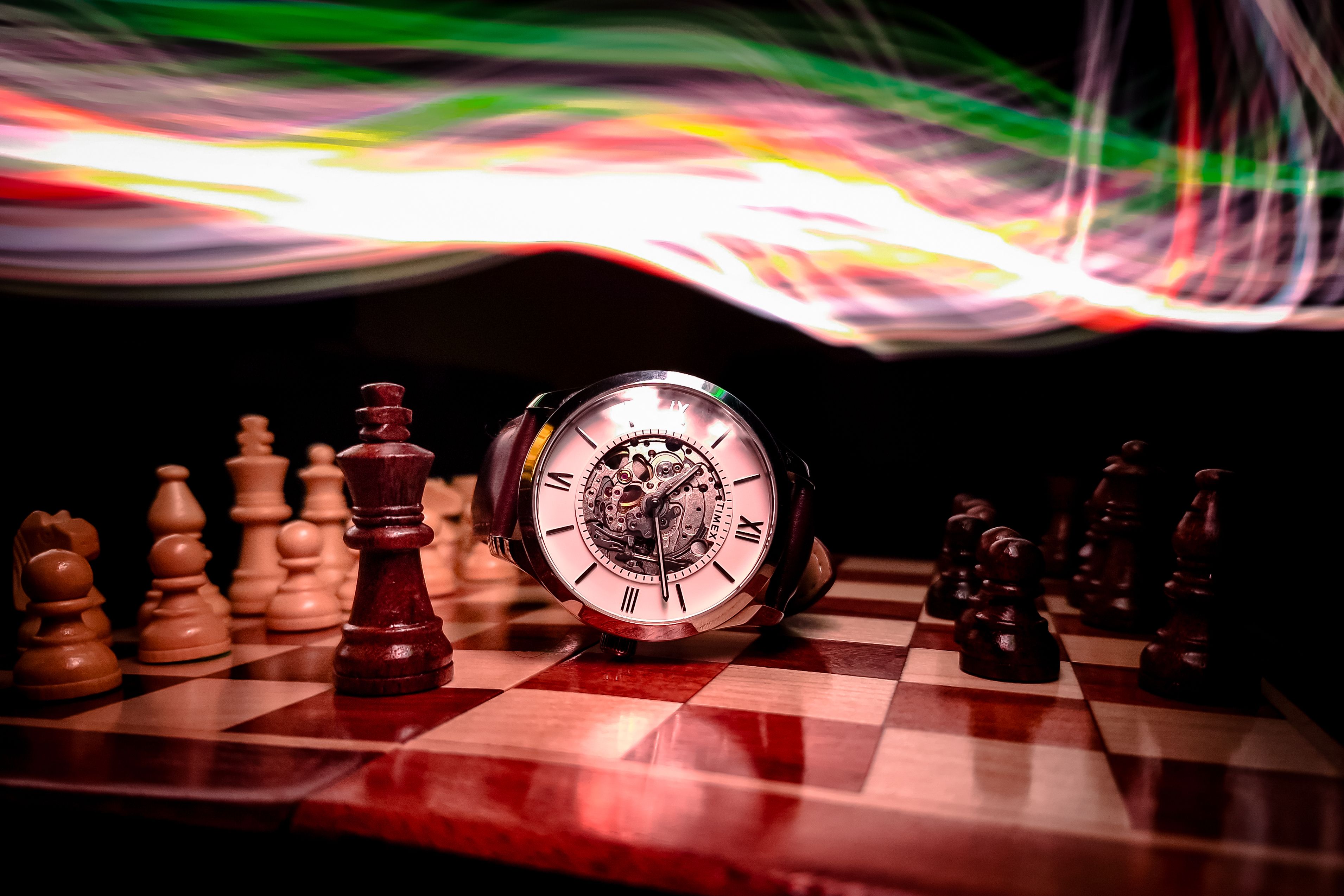 Intricate Watch on Chessboard Surrounded by Light · Free Stock Photo