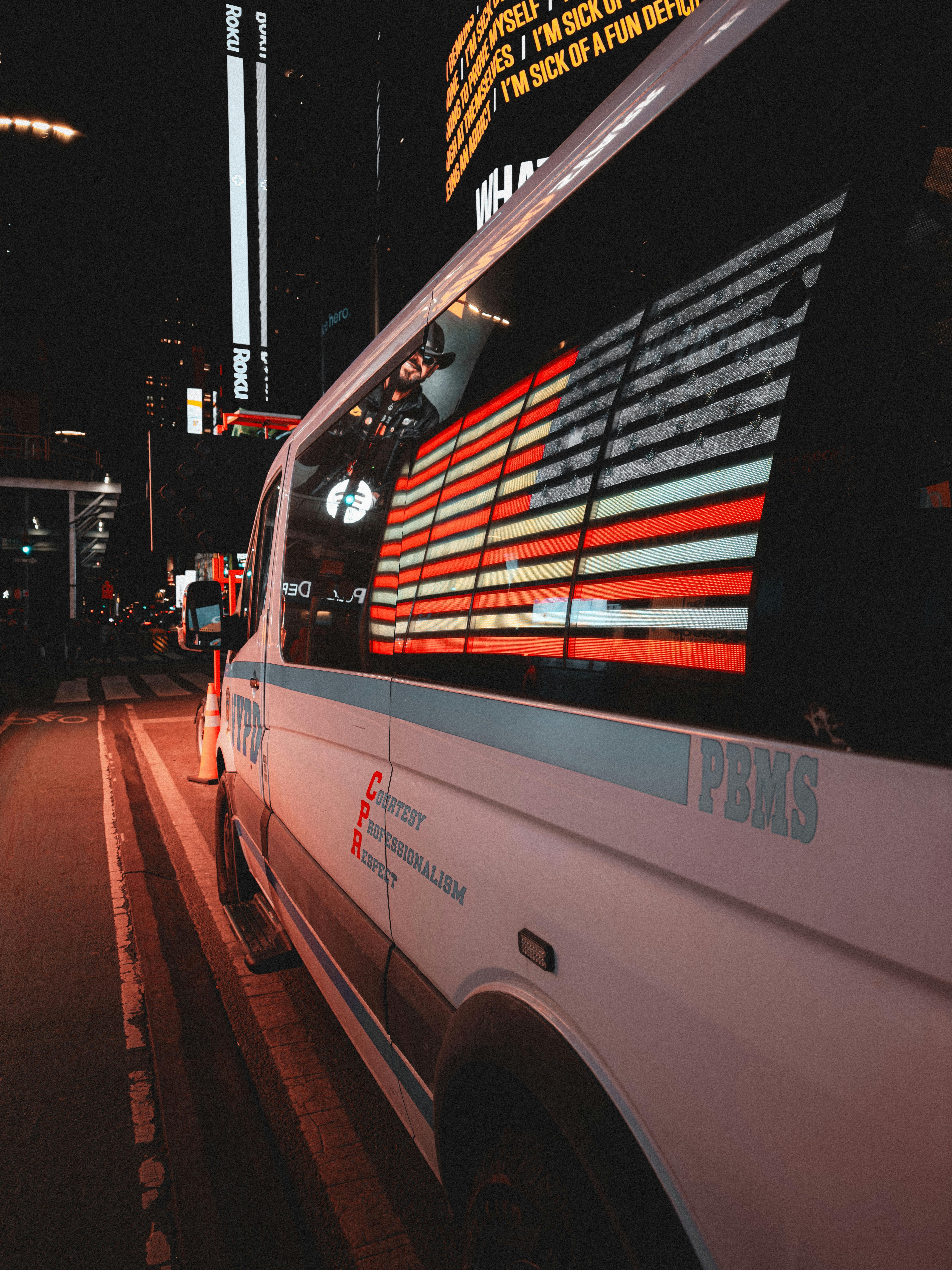 Ambulance with Reflective American Flag at Night · Free Stock Photo