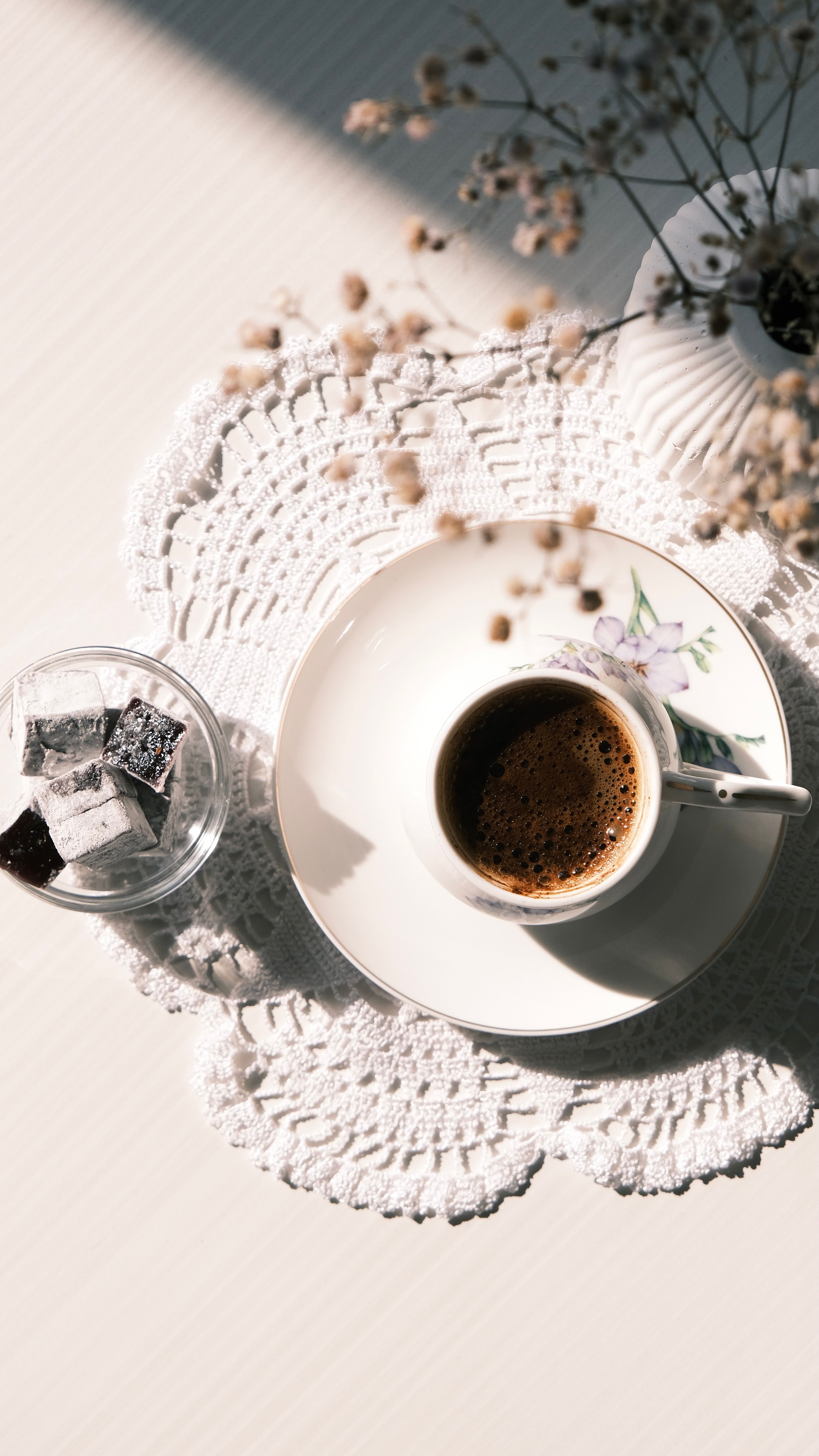 Elegant Coffee Cup on Lace Doily in Sunlight · Free Stock Photo