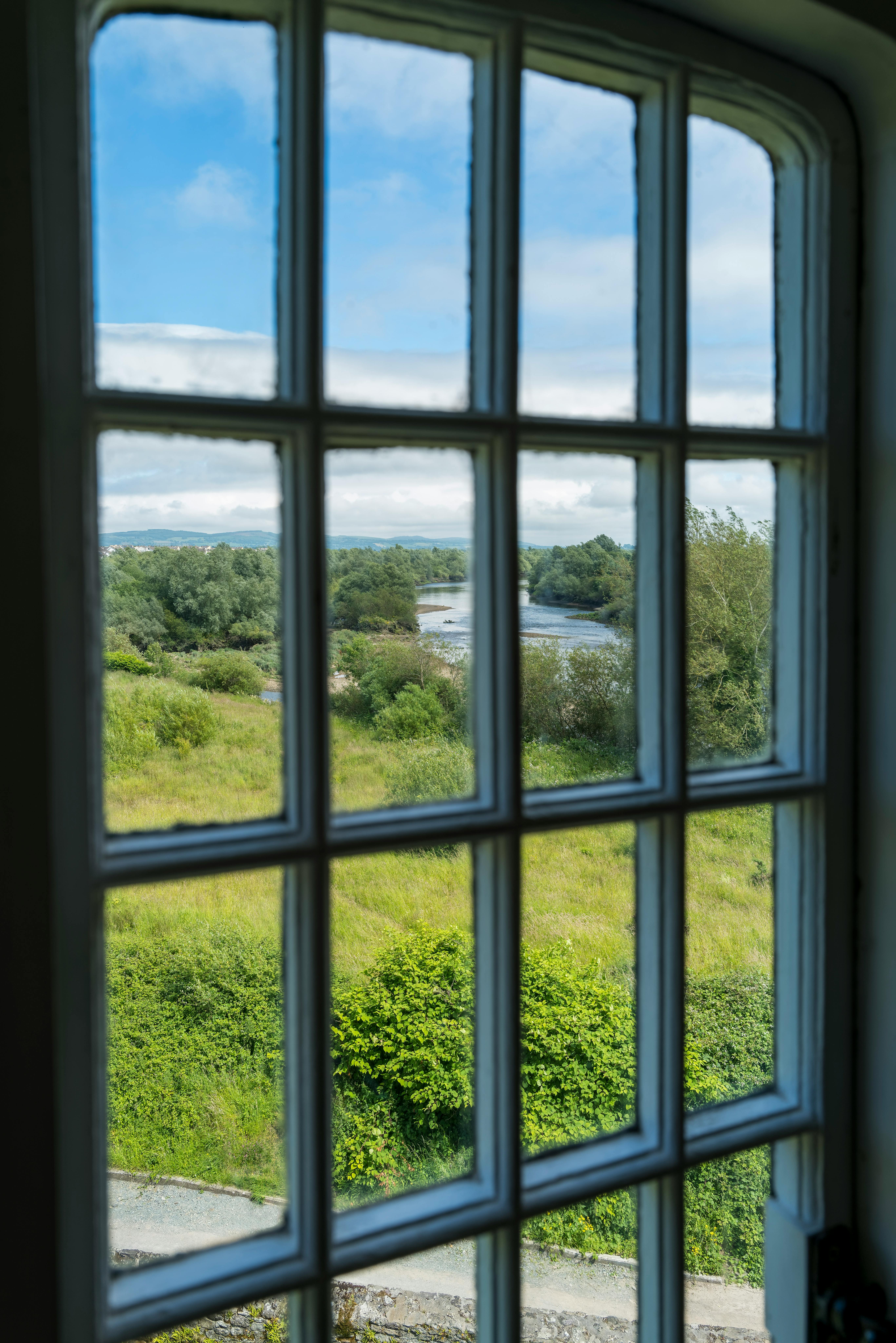 Scenic Countryside View Through Classic Window · Free Stock Photo