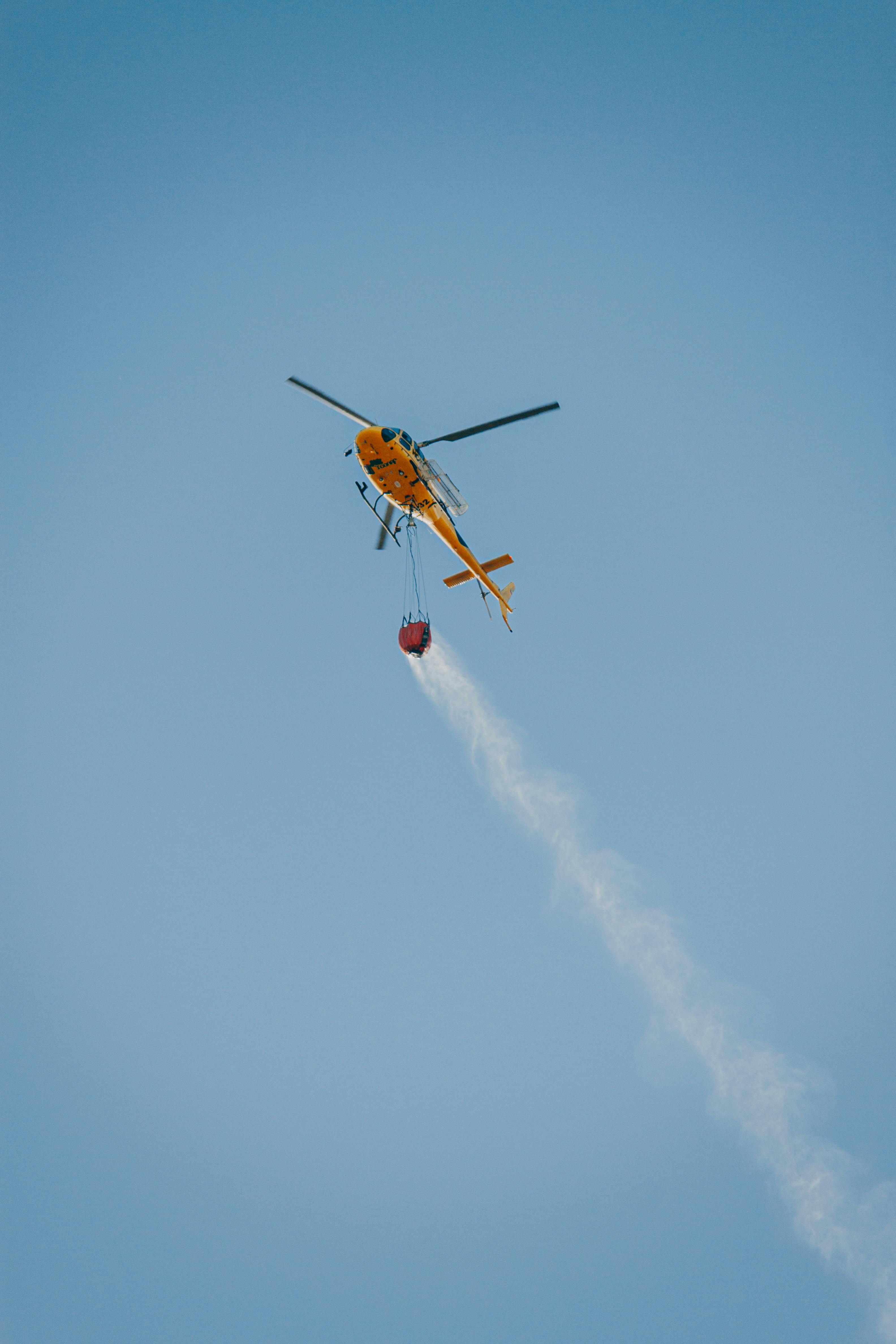 Helicopter Fighting Wildfire with Water Bucket · Free Stock Photo