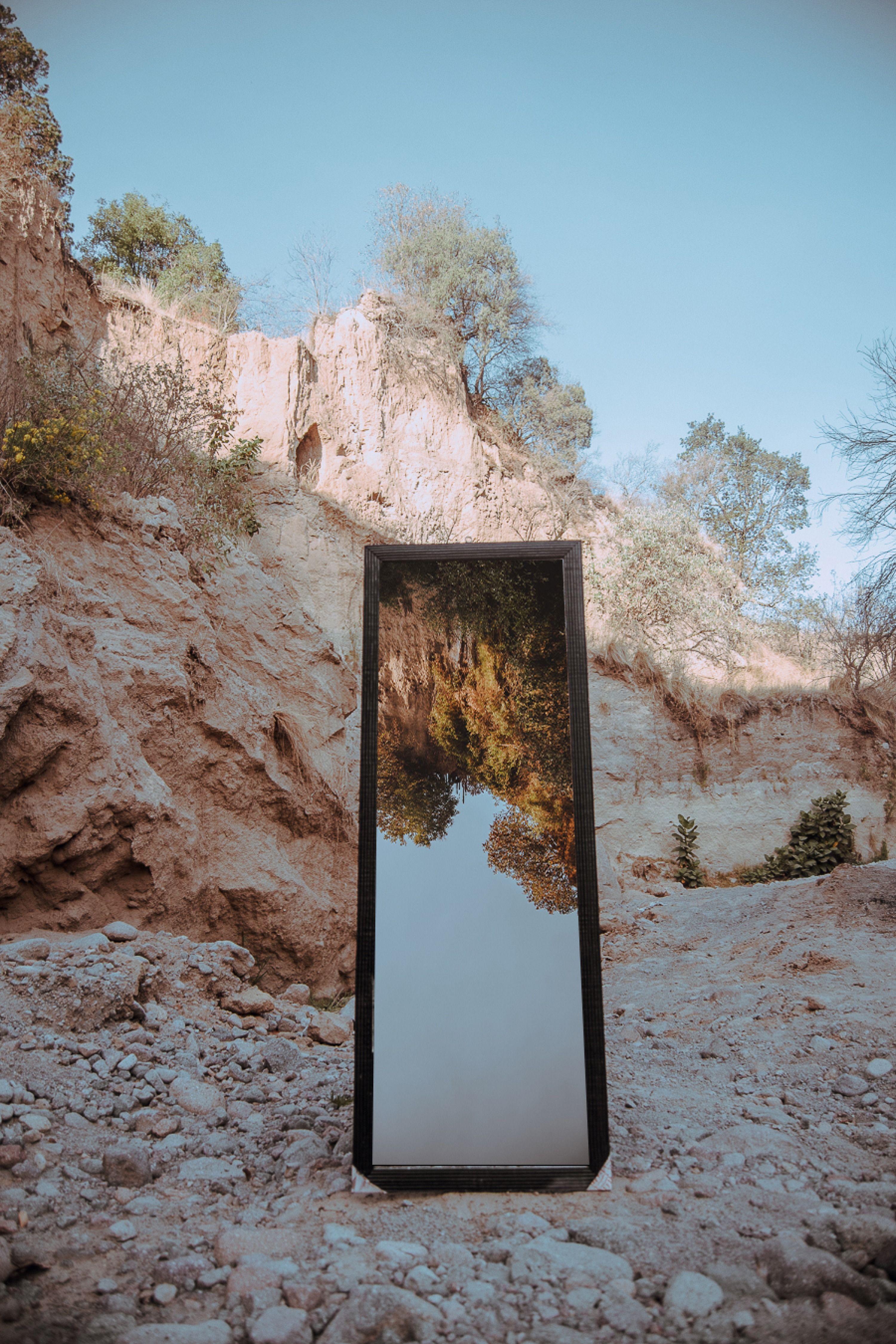 Mirror reflecting rocky landscape in nature · Free Stock Photo