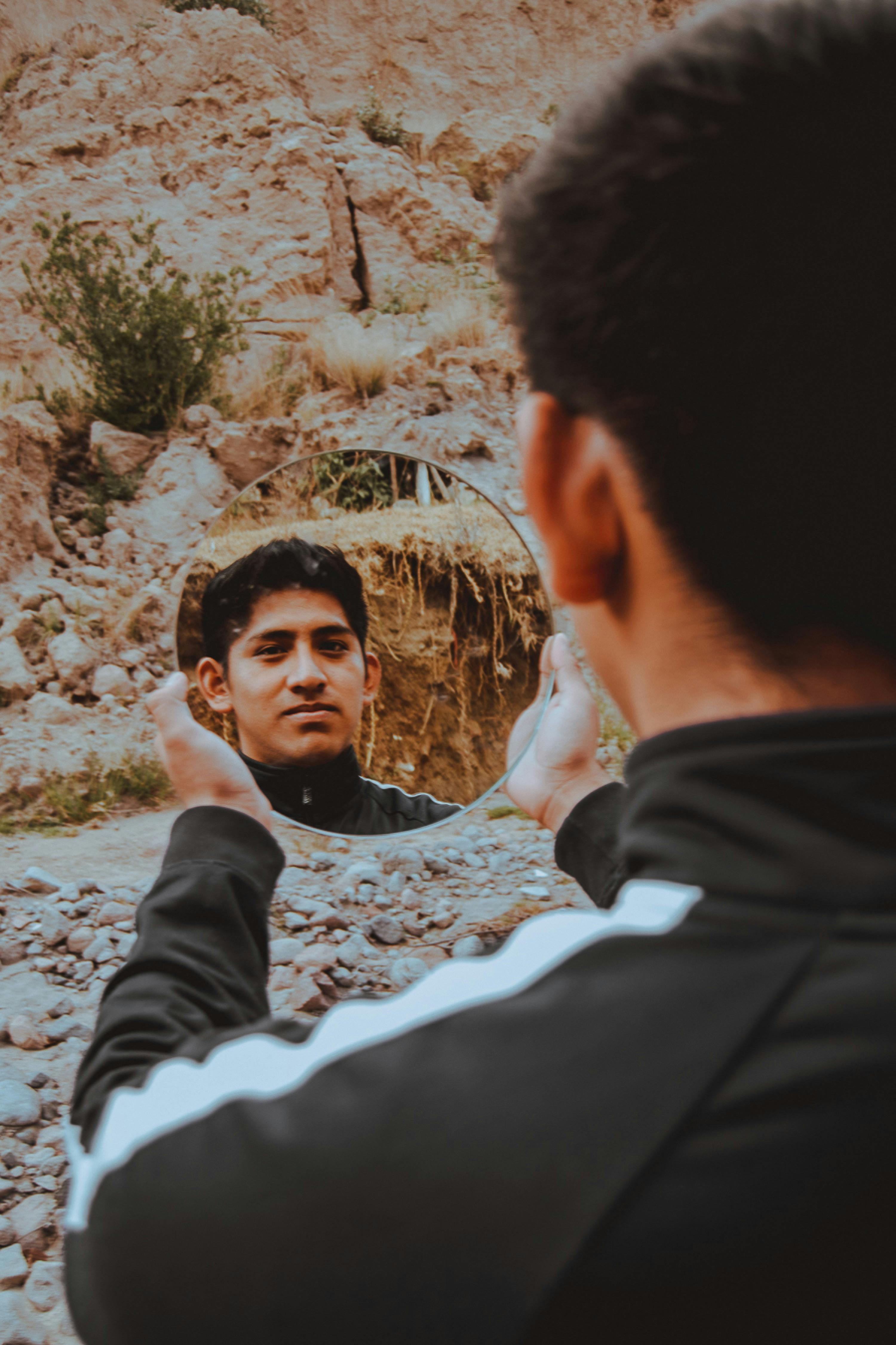 Reflective Portrait in Rocky Outdoor Setting · Free Stock Photo