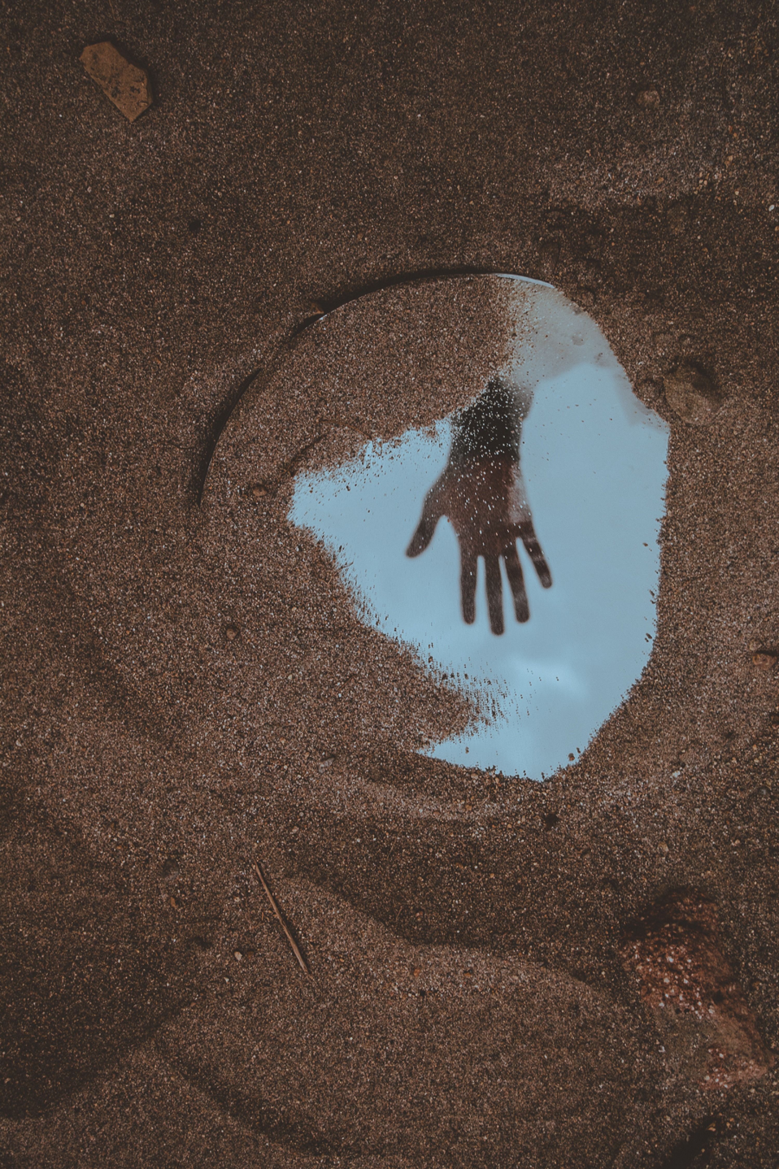 Hand Reflection in Sand Puddle on a Beach · Free Stock Photo