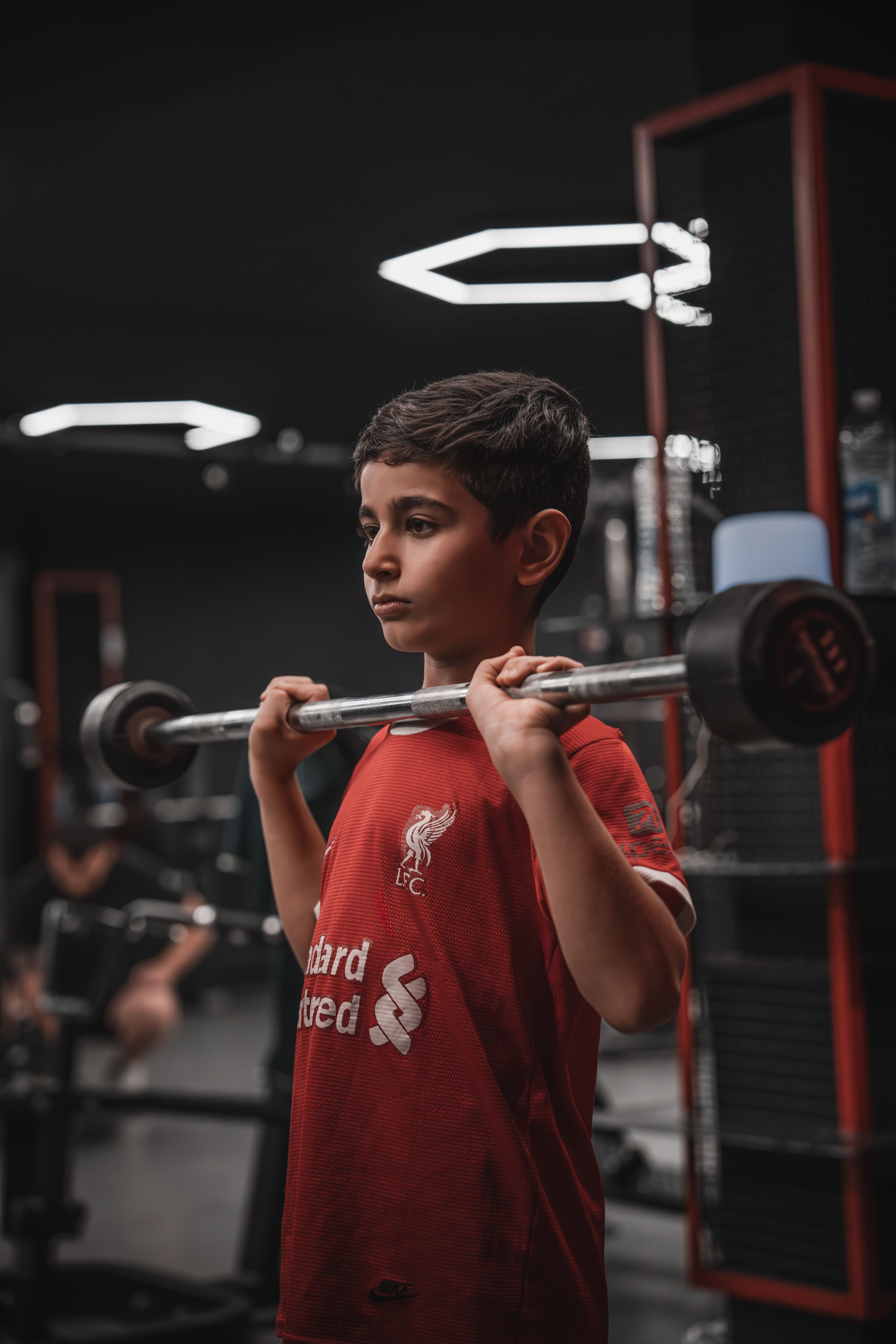 Young Boy Lifting Weights in Gym · Free Stock Photo