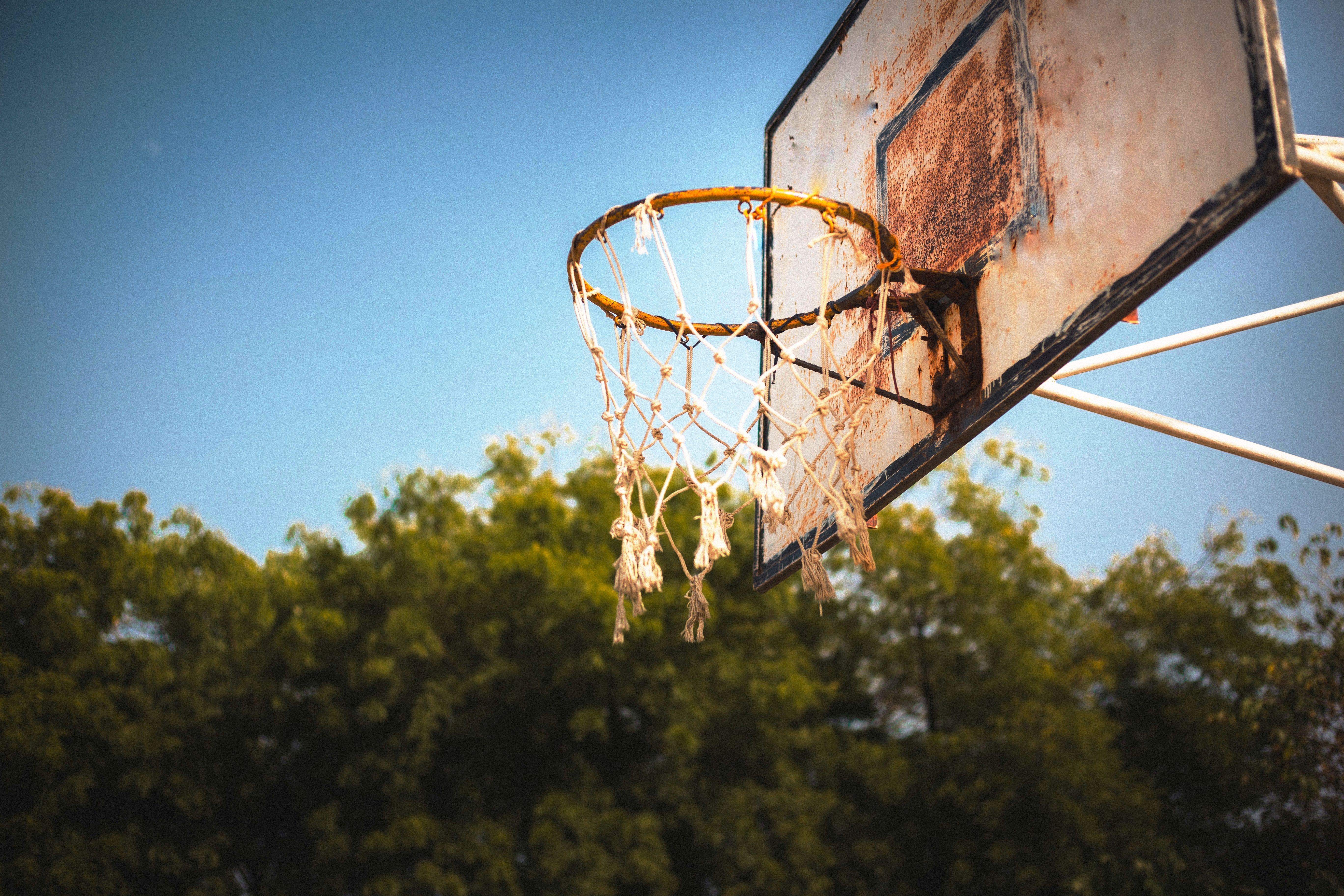 Rustic Outdoor Basketball Hoop Under Clear Sky · Free Stock Photo