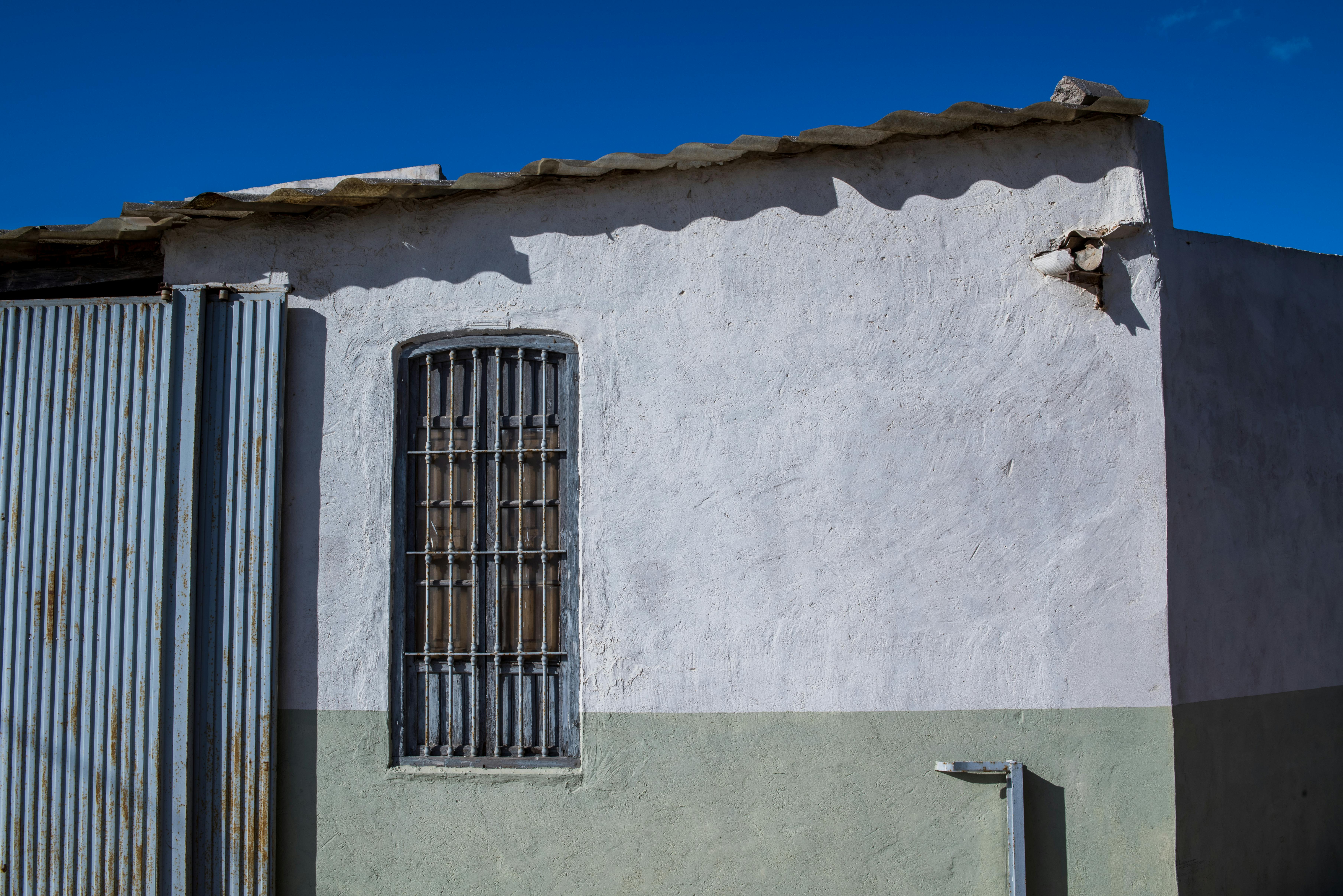 Rustic White Wall with Metal Barred Window · Free Stock Photo