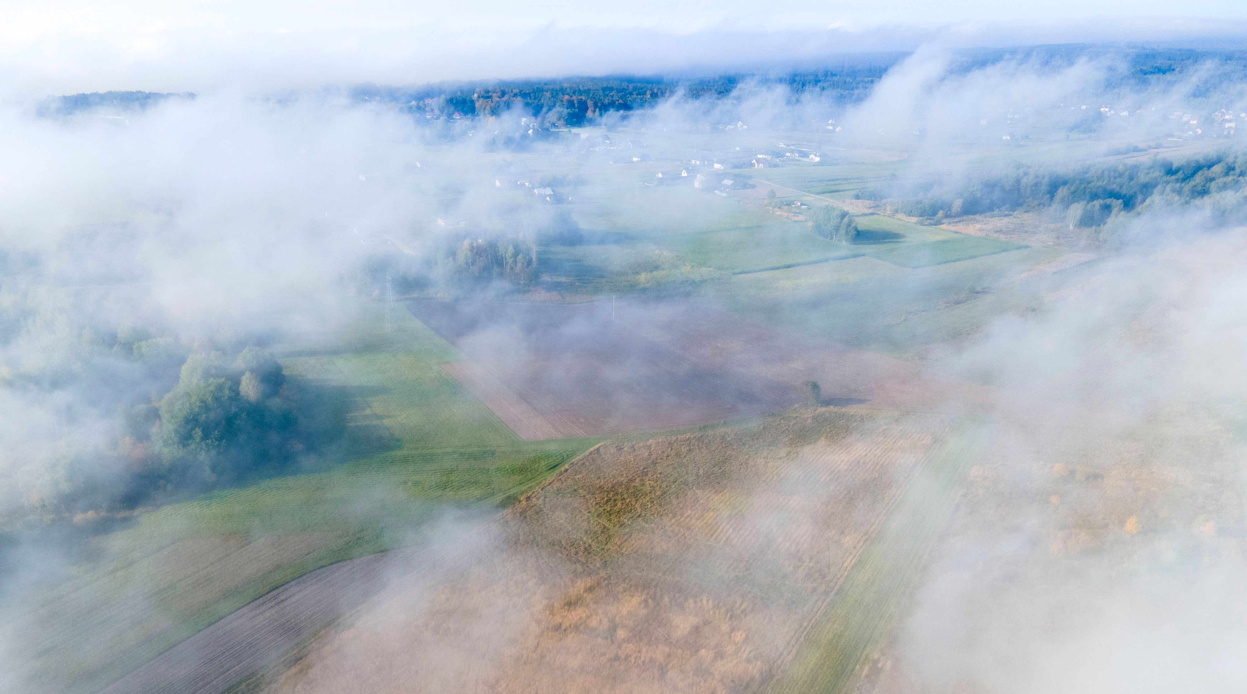 Aerial View of Foggy Farm Fields in Autumn · Free Stock Photo