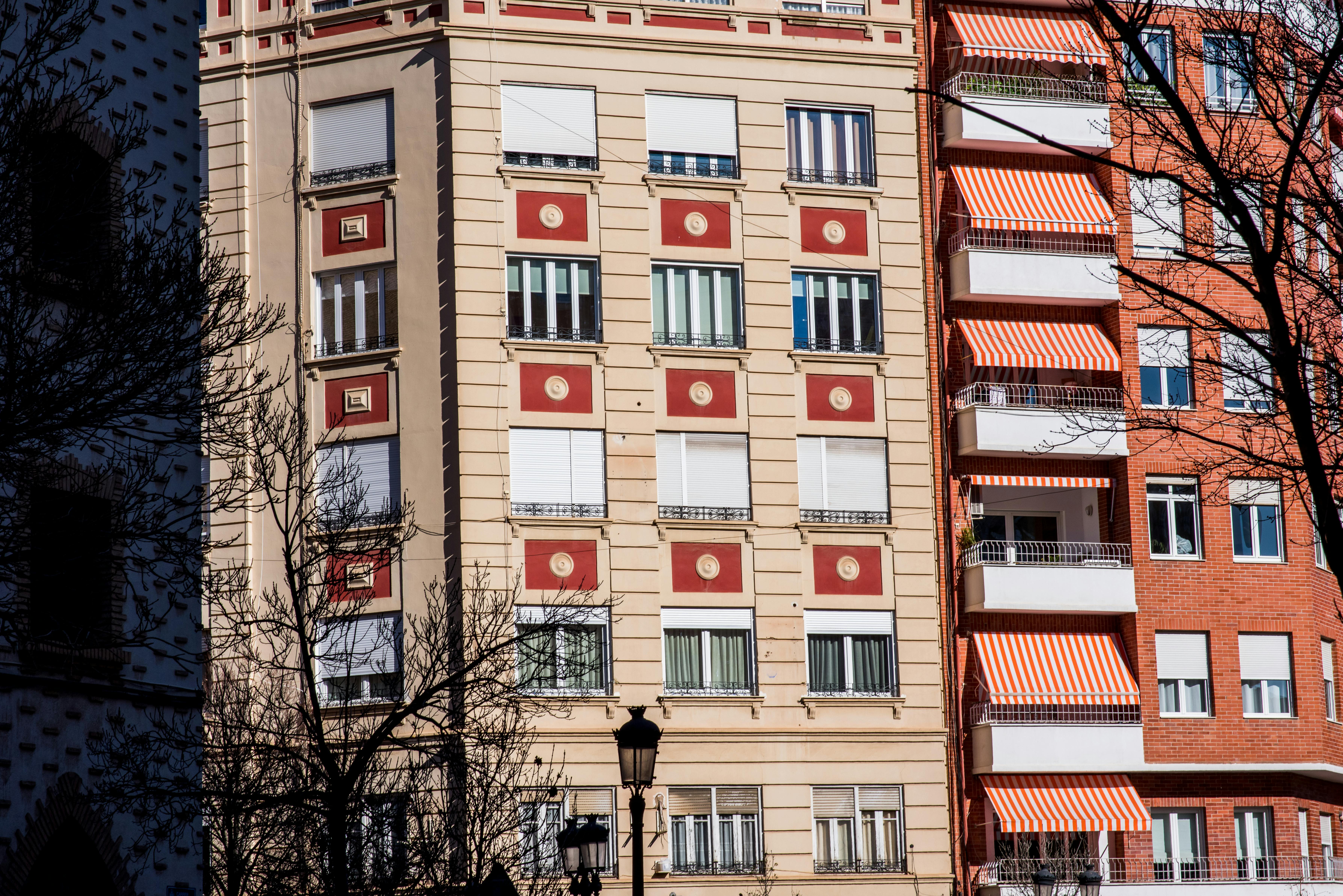 Colorful Urban Buildings with Striped Awnings · Free Stock Photo