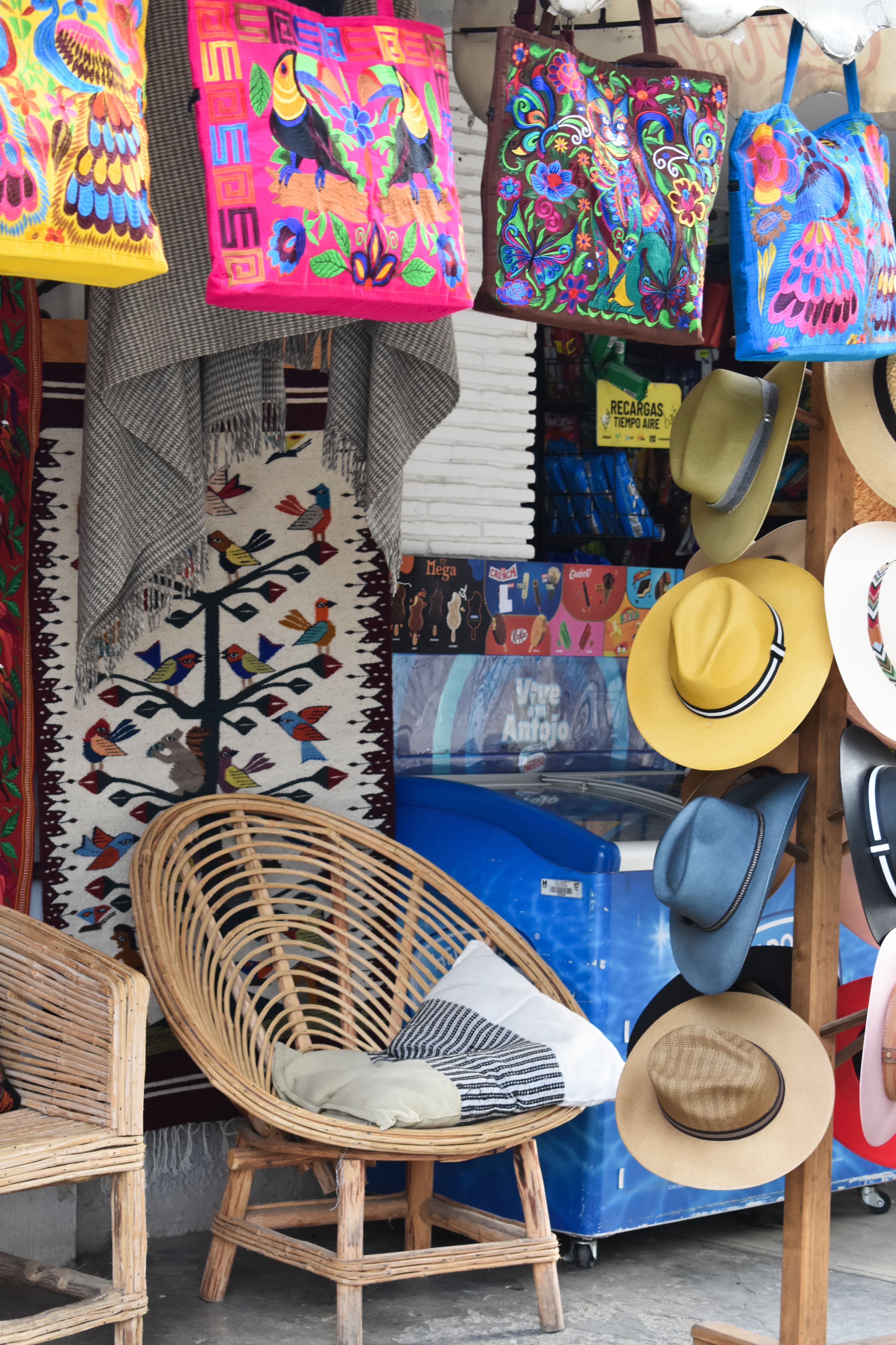 Vibrant Mexican Market Stall with Hats and Textiles · Free Stock Photo