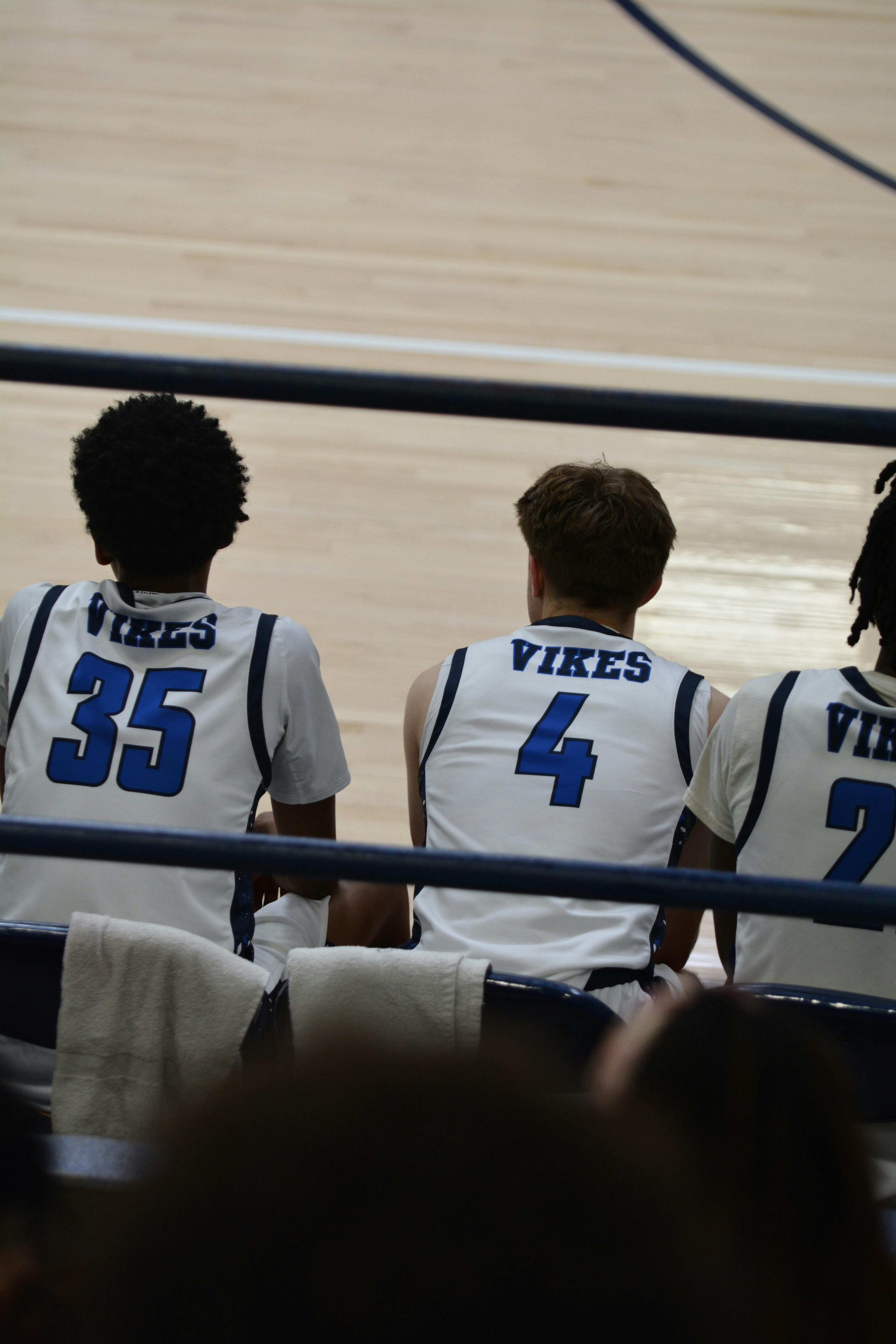 High School Basketball Team Players Resting on Bench · Free Stock Photo