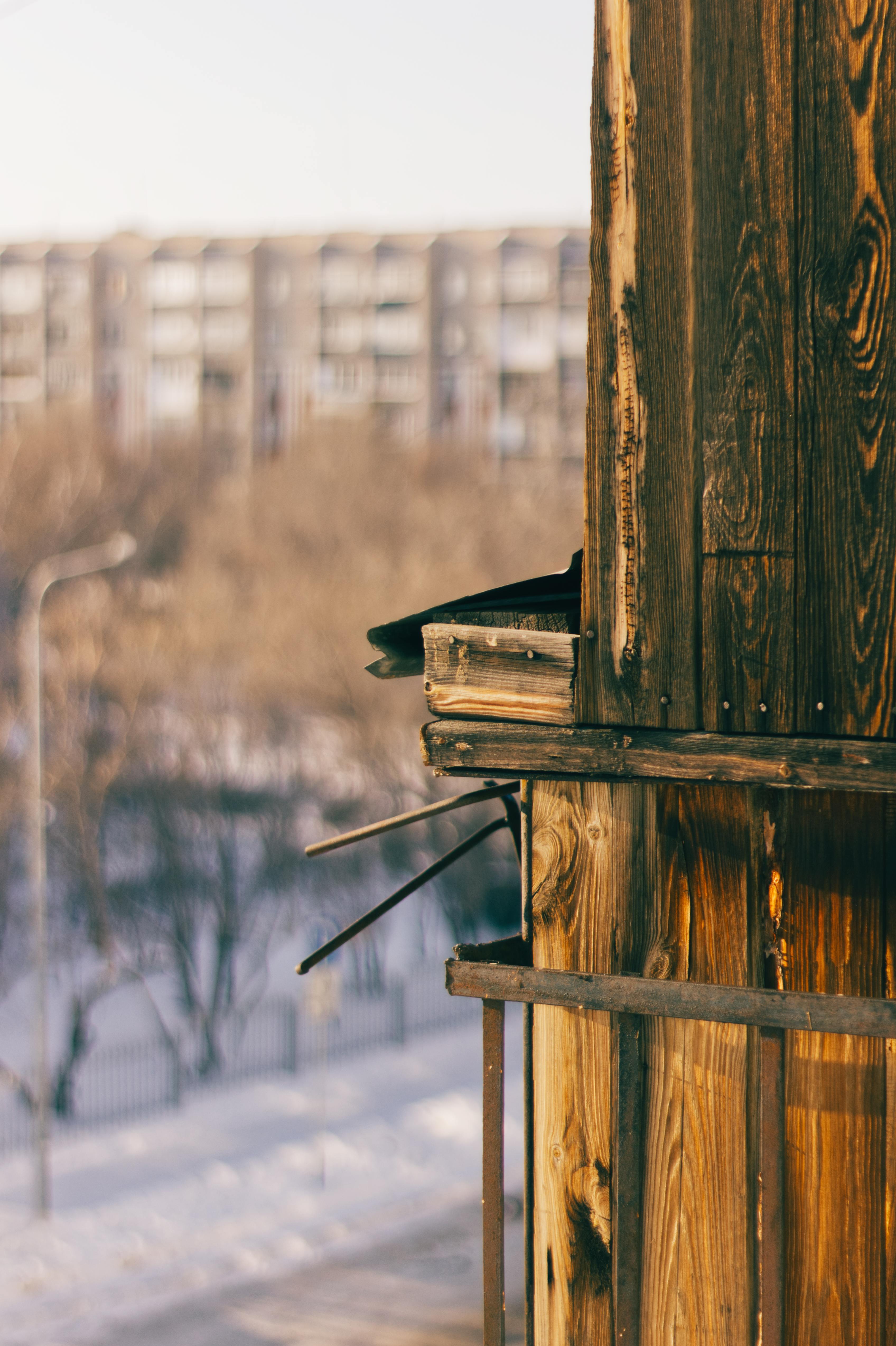 Vintage Wooden Balcony in Winter Urban Setting · Free Stock Photo