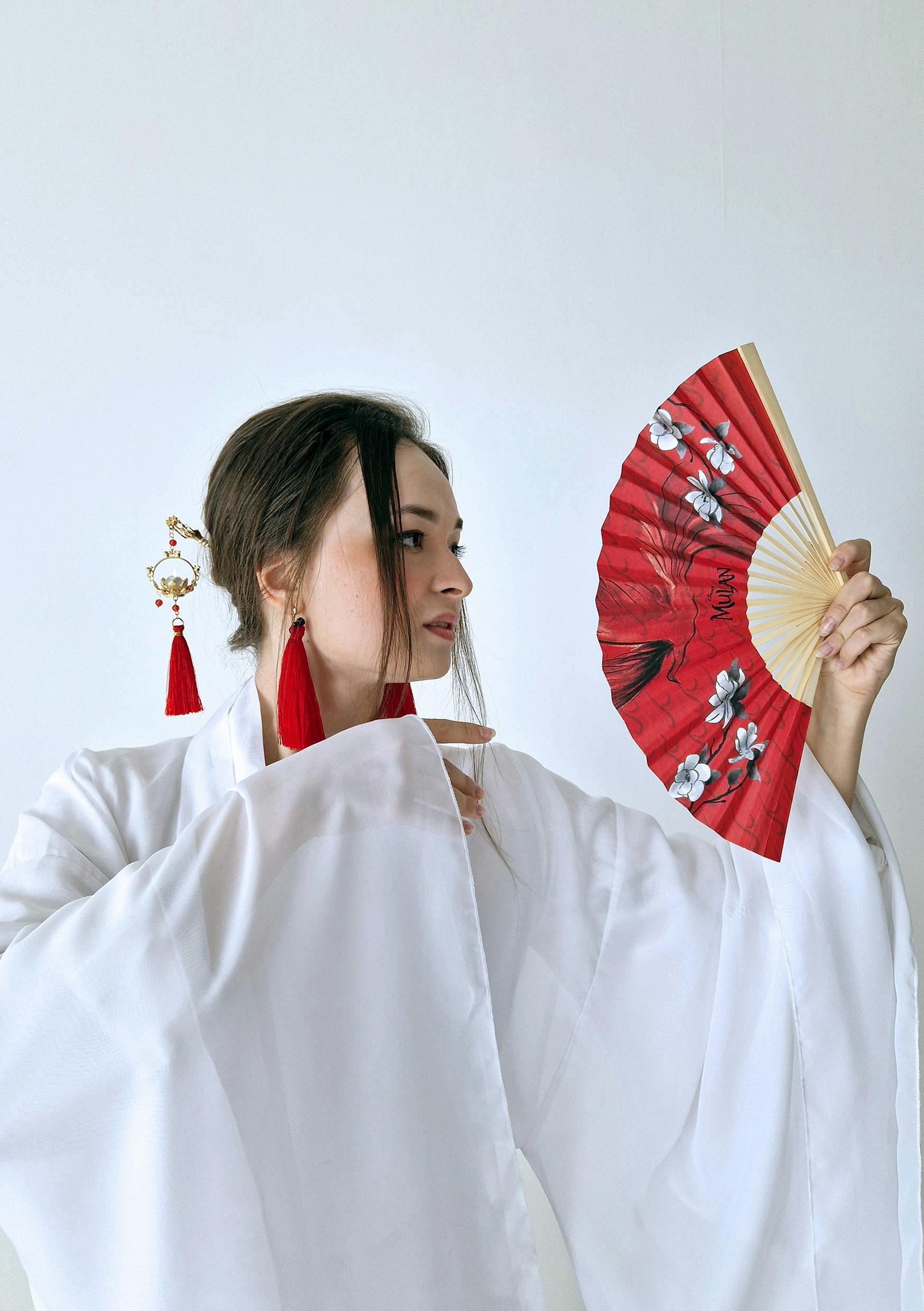 Young Woman Holding Red Chinese Fan in Traditional Attire · Free Stock ...