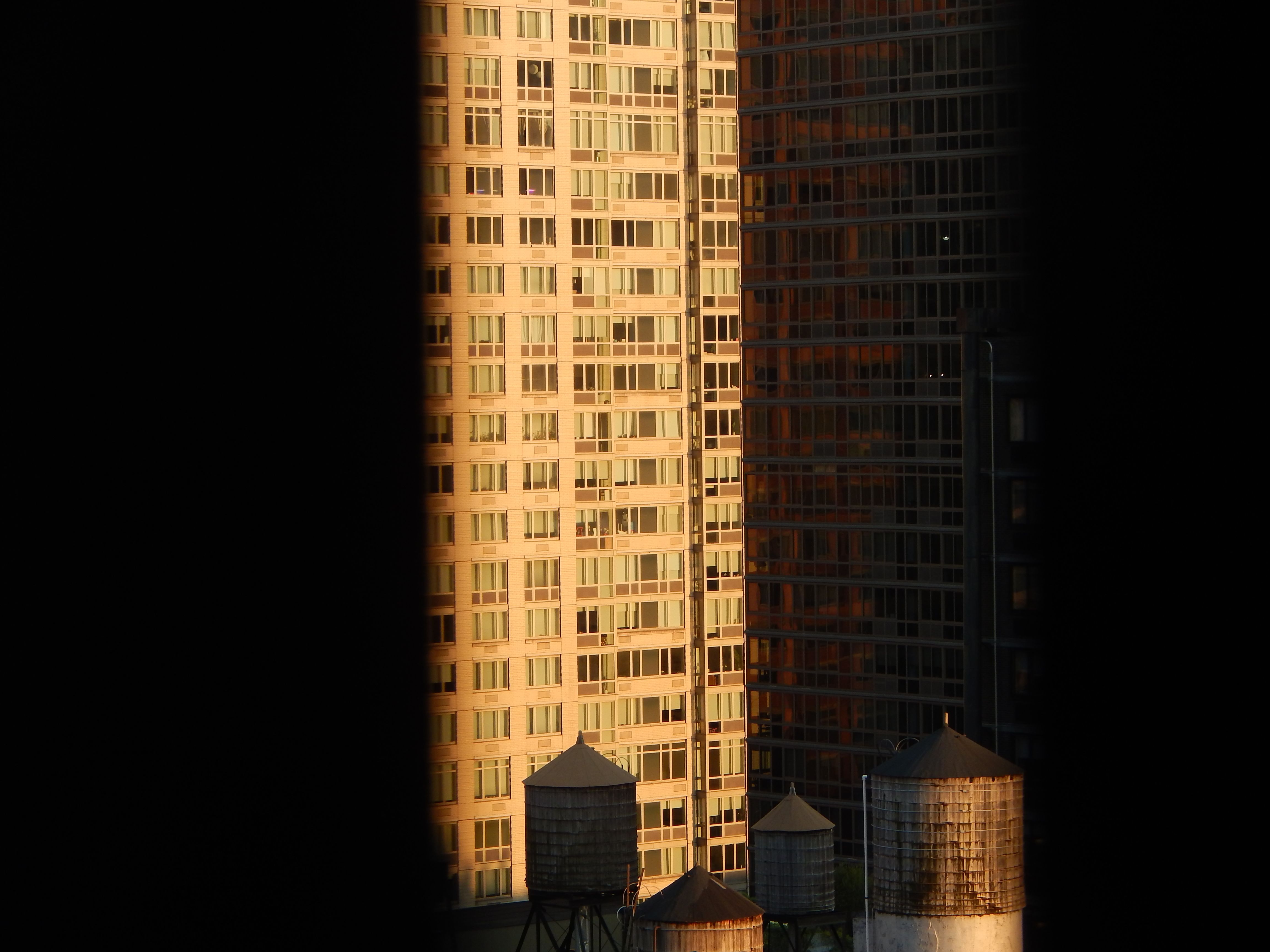 Urban Sunset with Water Towers and High-Rises · Free Stock Photo