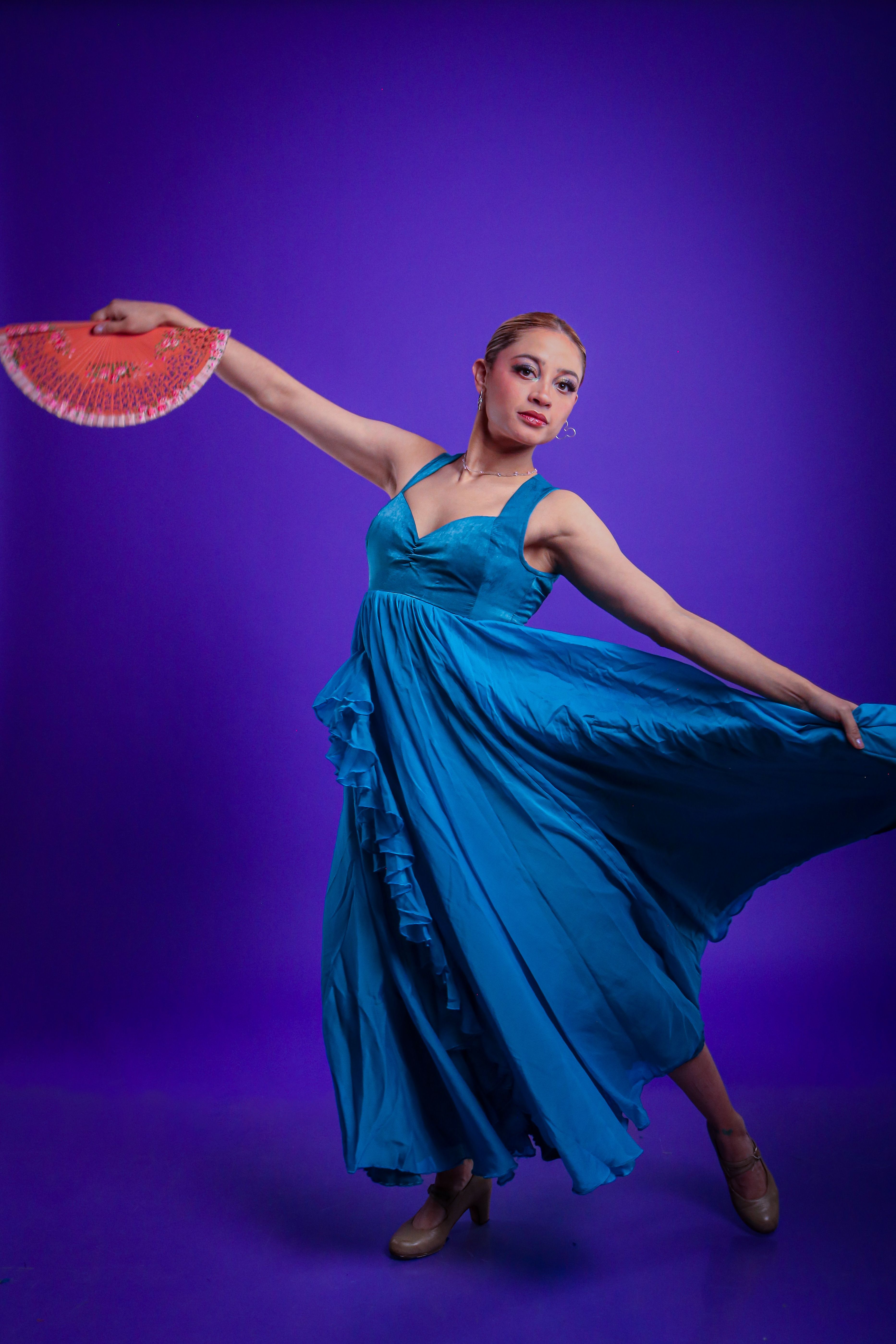 Elegant Dancer in Blue Dress Performing with Fan · Free Stock Photo