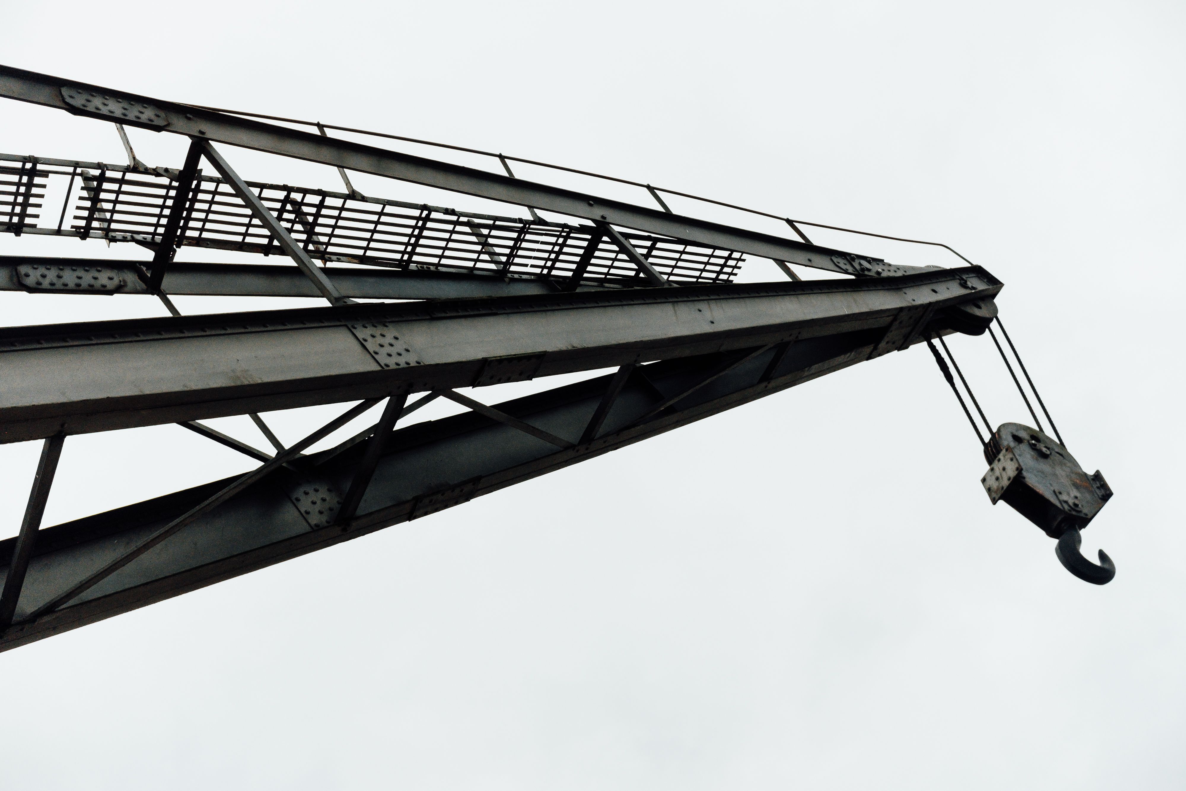 Industrial Crane Arm with Hook Against Sky · Free Stock Photo